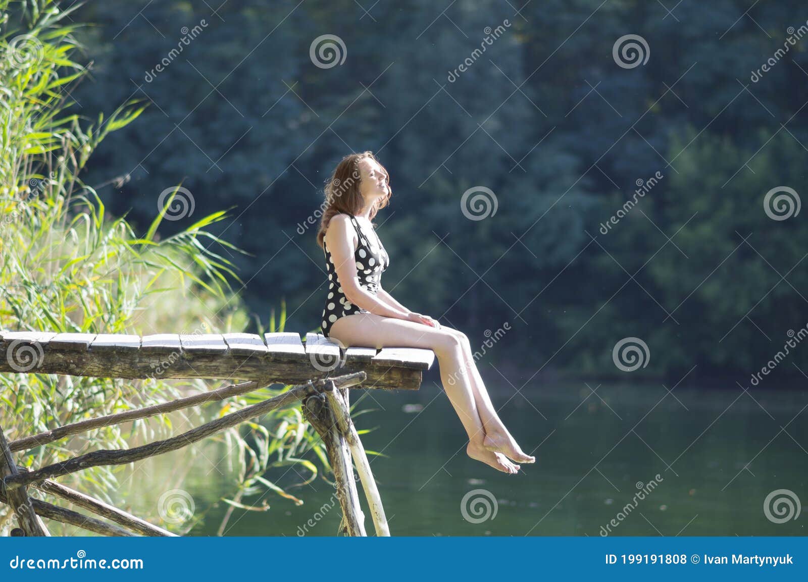 A Woman Sitting on a Bridge Stock Photo - Image of swimsuit, sunlight ...