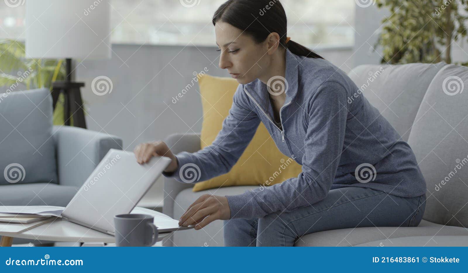 Woman Sitting on the Couch and Using Her Laptop Stock Image - Image of ...