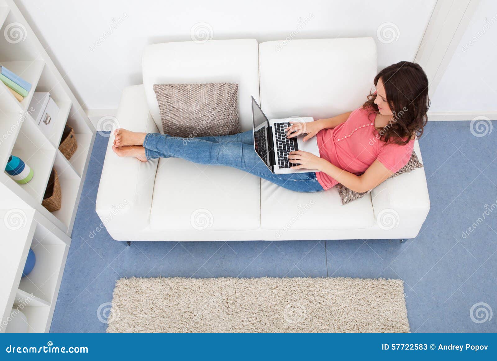 Woman Sitting on Couch Using Laptop Stock Image - Image of pillow ...