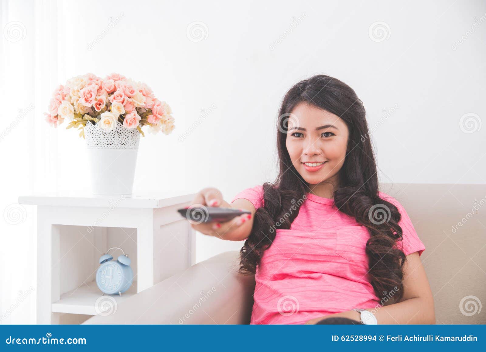 Woman Sitting on a Couch, Using Remote Control Stock Photo - Image of ...