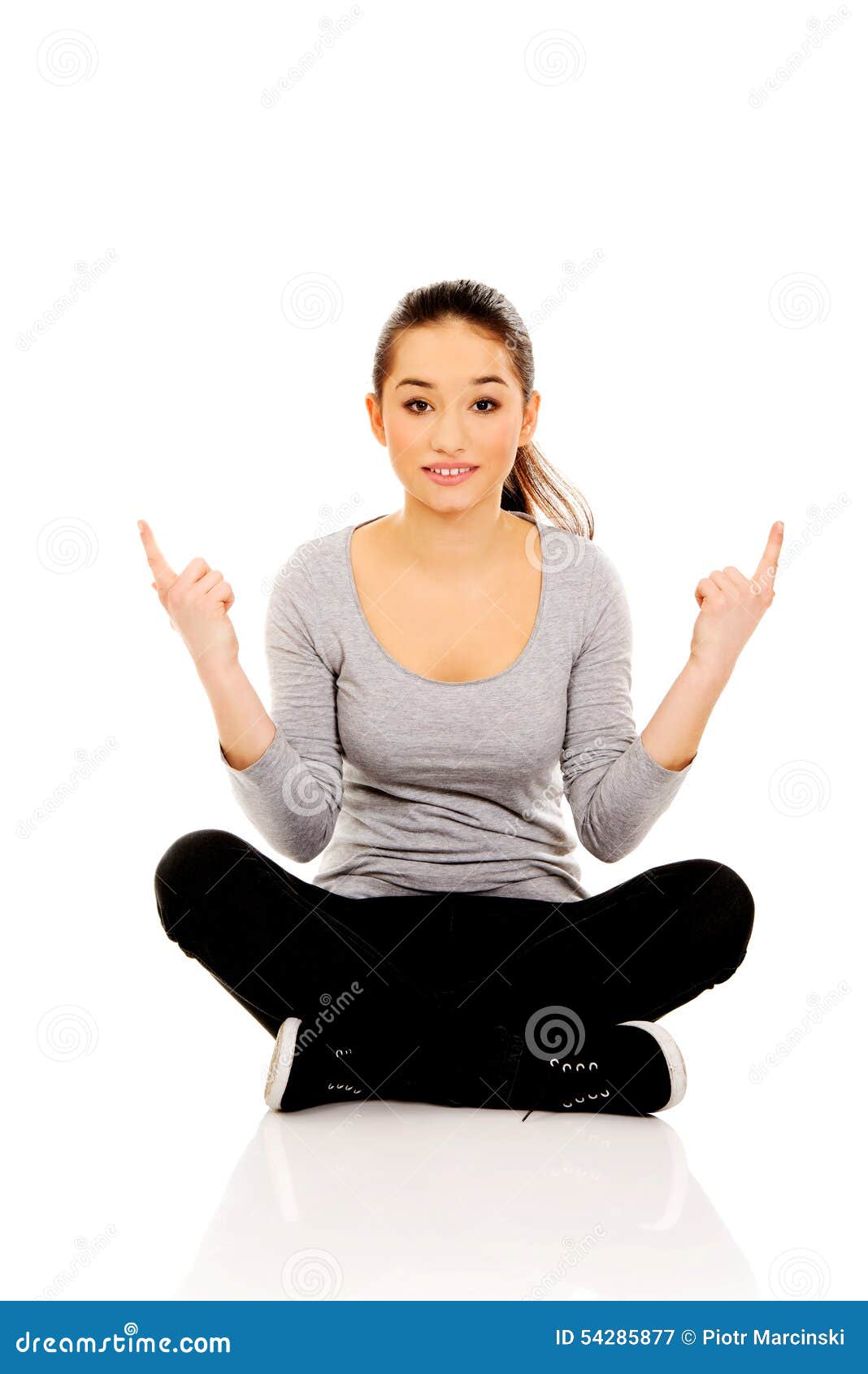 Woman Sitting Cross Legged Pointing Up. Stock Image - Image of people ...