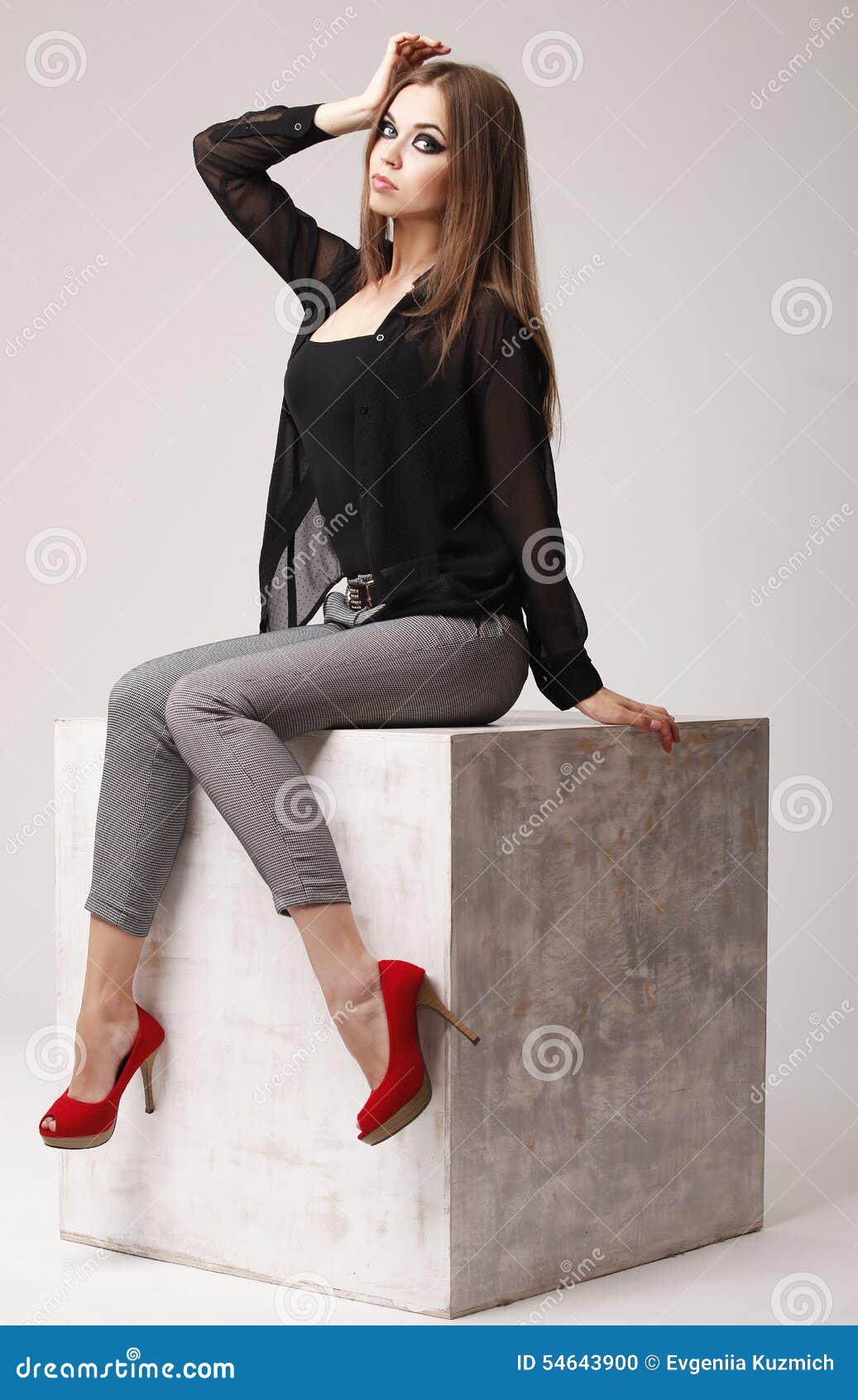 Woman sitting on cube stock photo. Image of stylish, blue - 54643900