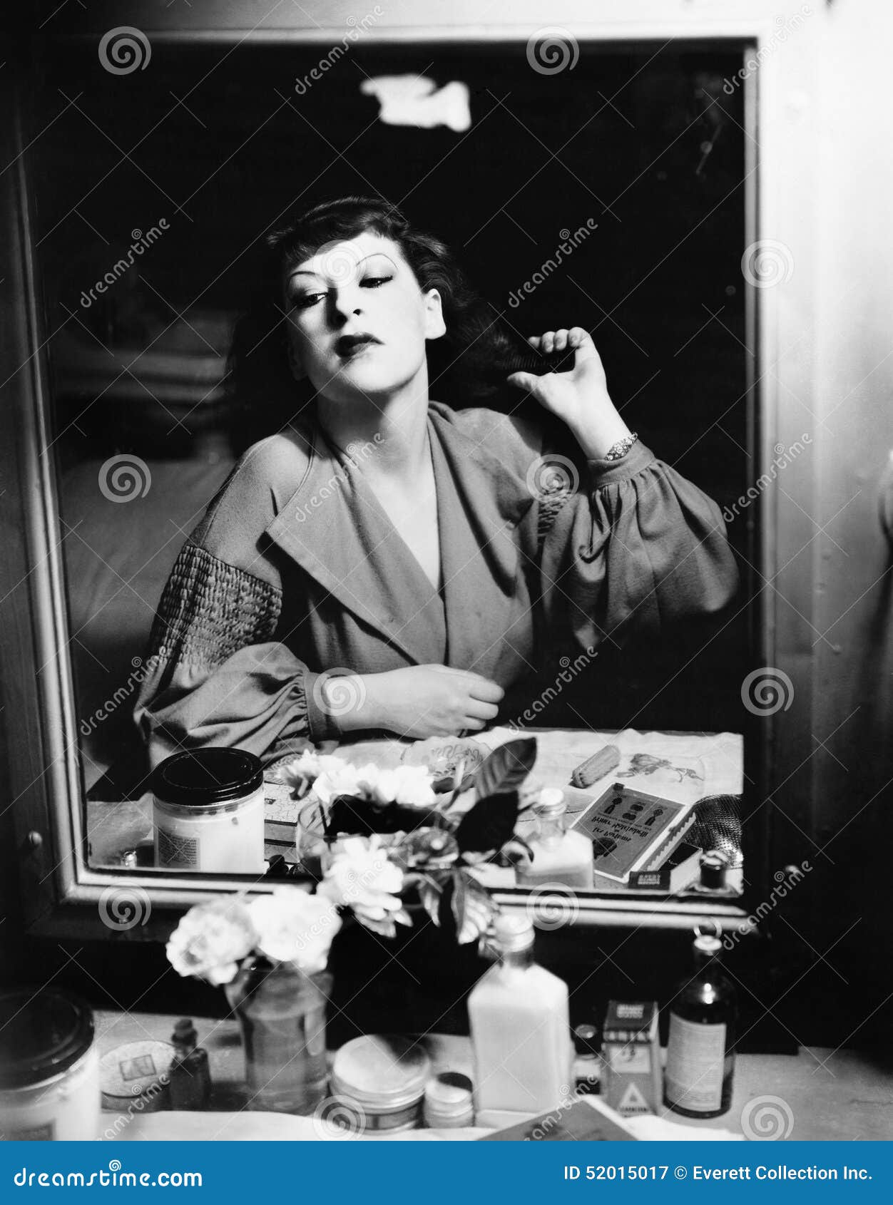 Woman Sitting in Front of Her Vanity Looking into the Mirror Stock ...