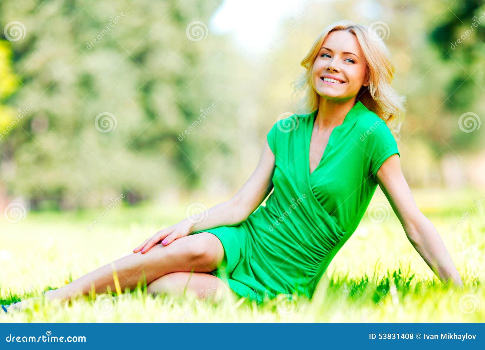 Woman sitting on grass stock photo. Image of beautiful - 53831408