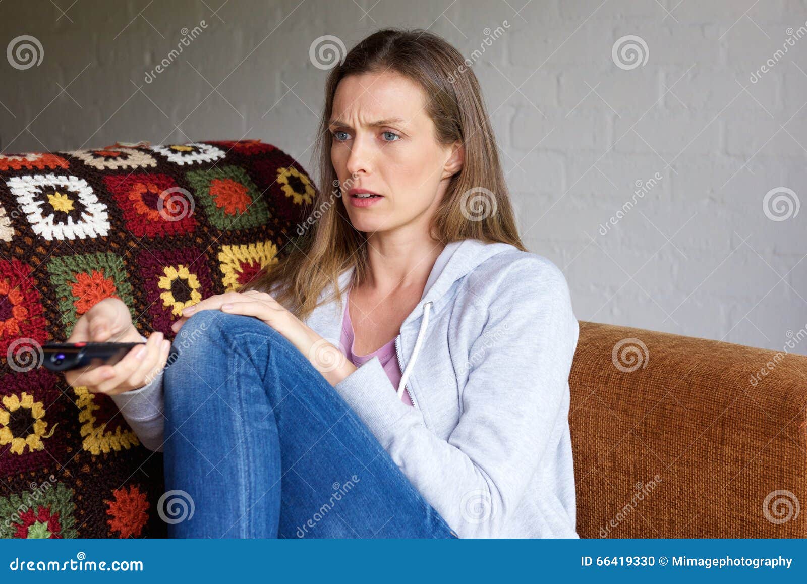Woman Sitting at Home with Remote Control Stock Photo - Image of ...