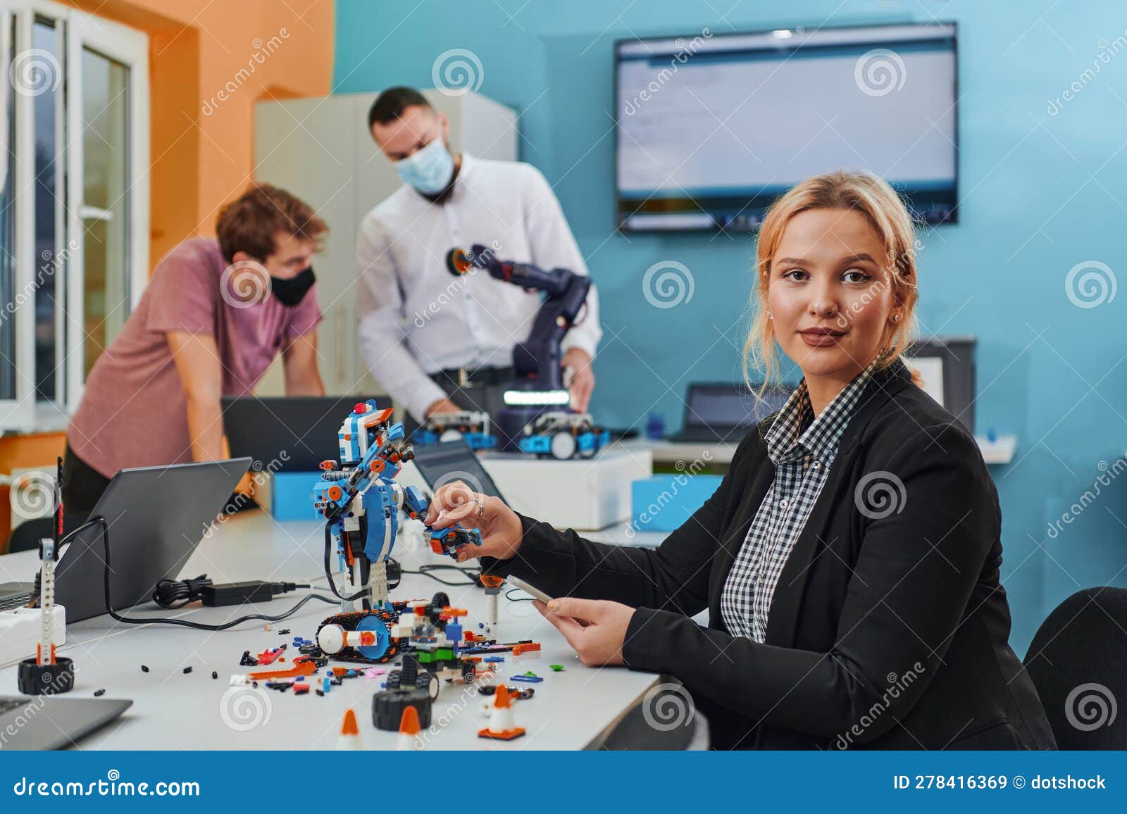 A Woman Sitting in a Laboratory and Solving Problems and Analyzing the ...