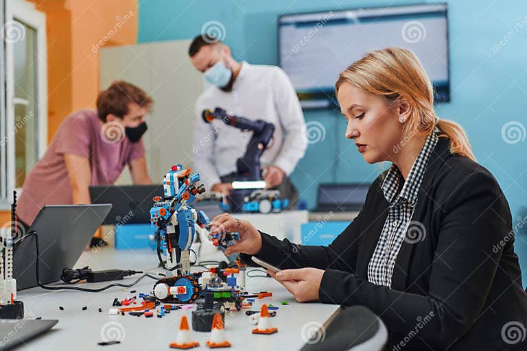 A Woman Sitting in a Laboratory and Solving Problems and Analyzing the ...