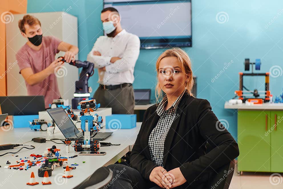 A Woman Sitting in a Laboratory and Solving Problems and Analyzing the ...