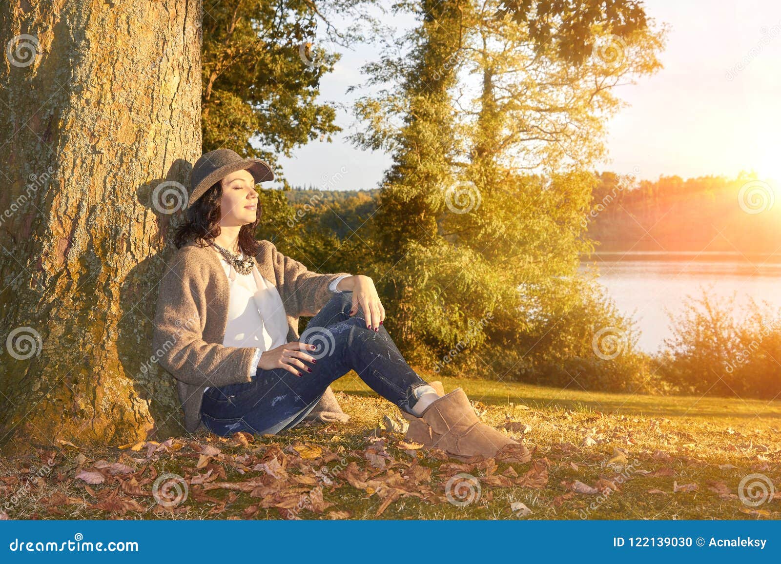 Woman Sitting Leaning on Tree in Fall Park Stock Photo - Image of ...