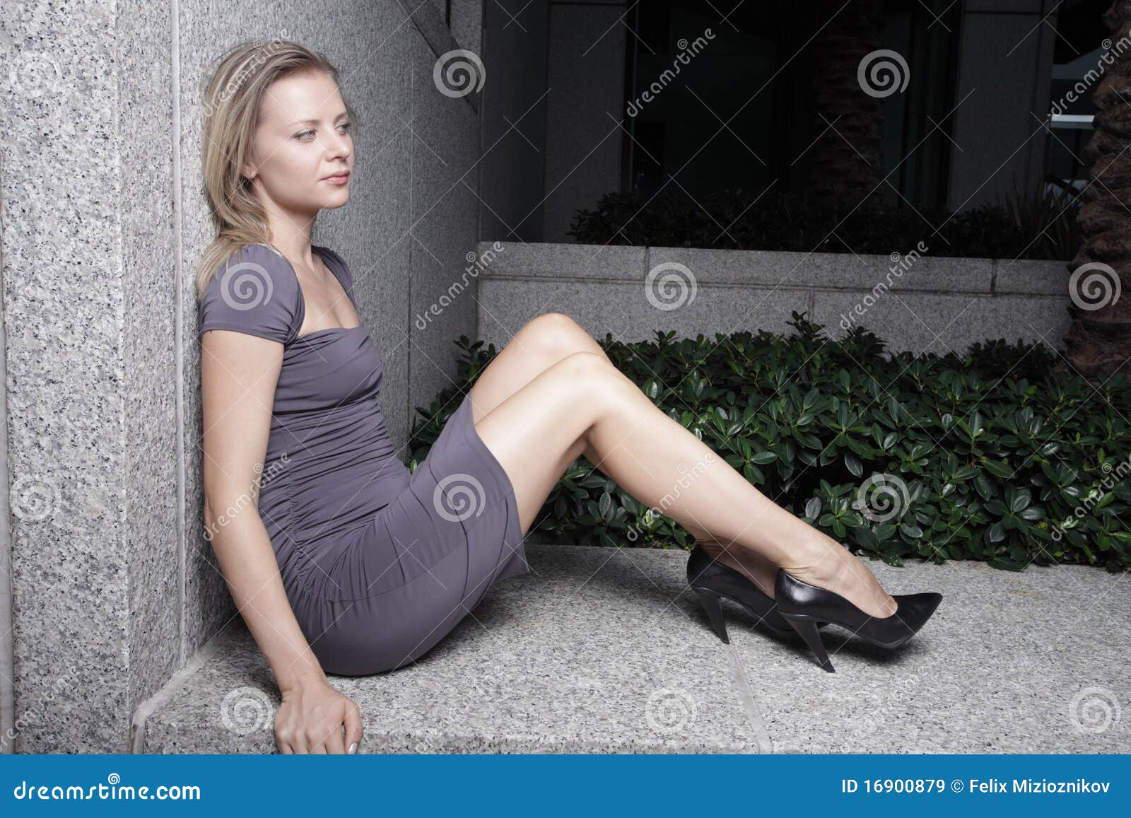 Woman sitting on a ledge stock image. Image of dark, beauty - 16900879