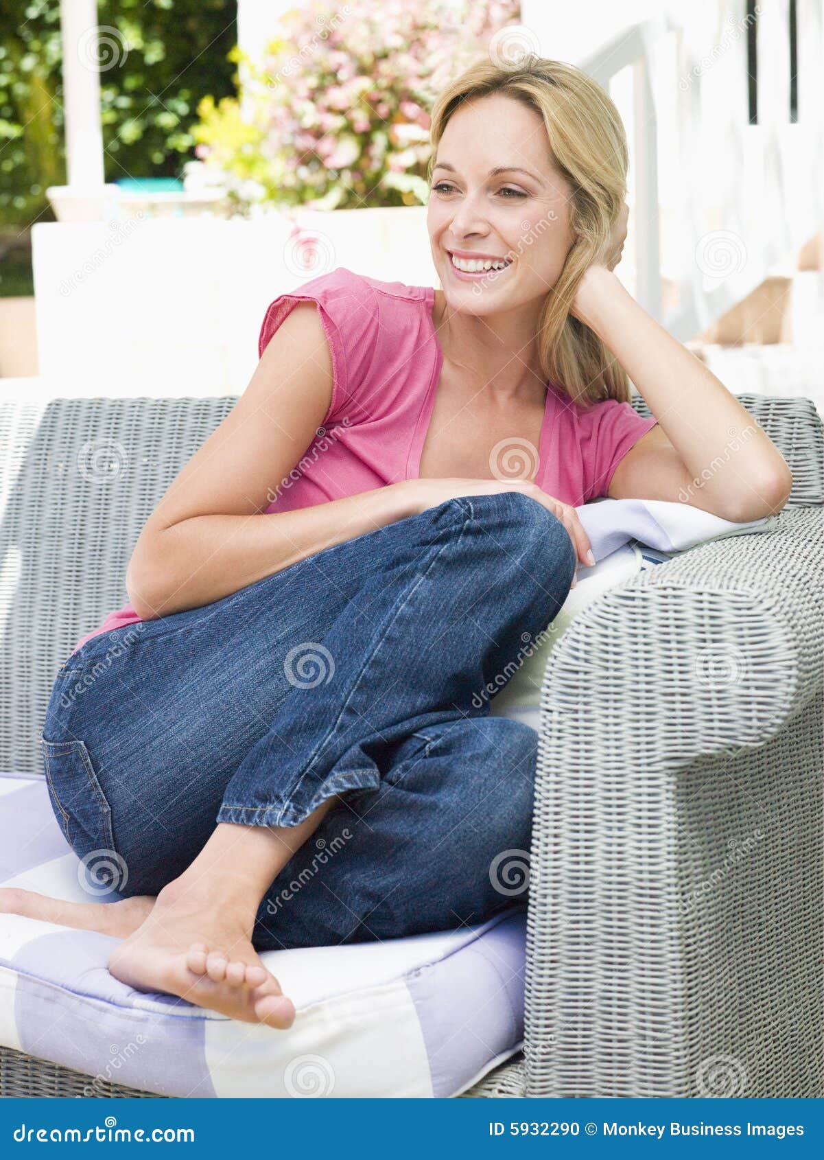 Woman Sitting Outdoors on Patio Smiling Stock Photo - Image of smiling ...