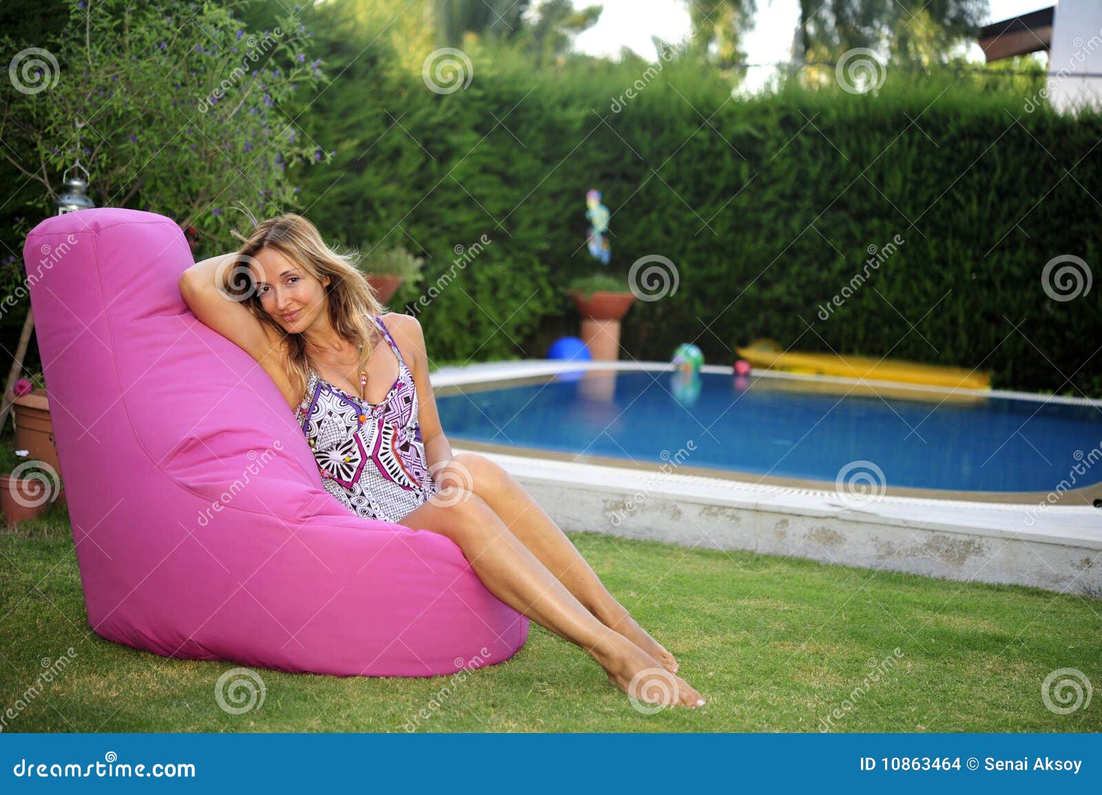 Woman sitting by pool stock photo. Image of lawn, caucasian - 10863464