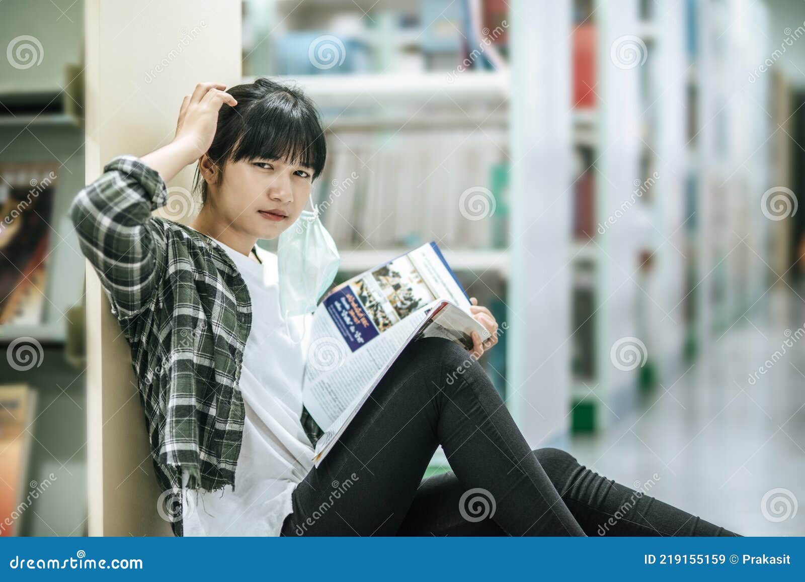 A Woman Sitting Reading a Book in the Library Stock Image - Image of ...