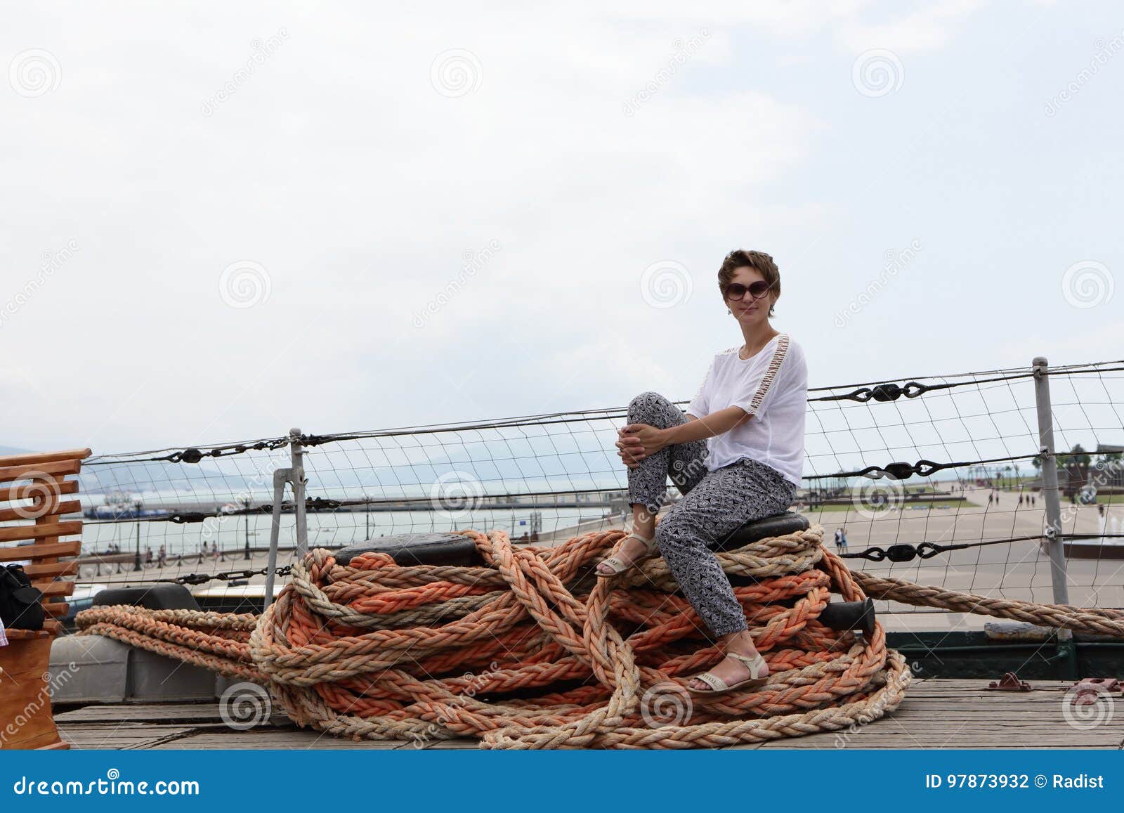 Woman sitting on rope stock photo. Image of knot, cord - 97873932