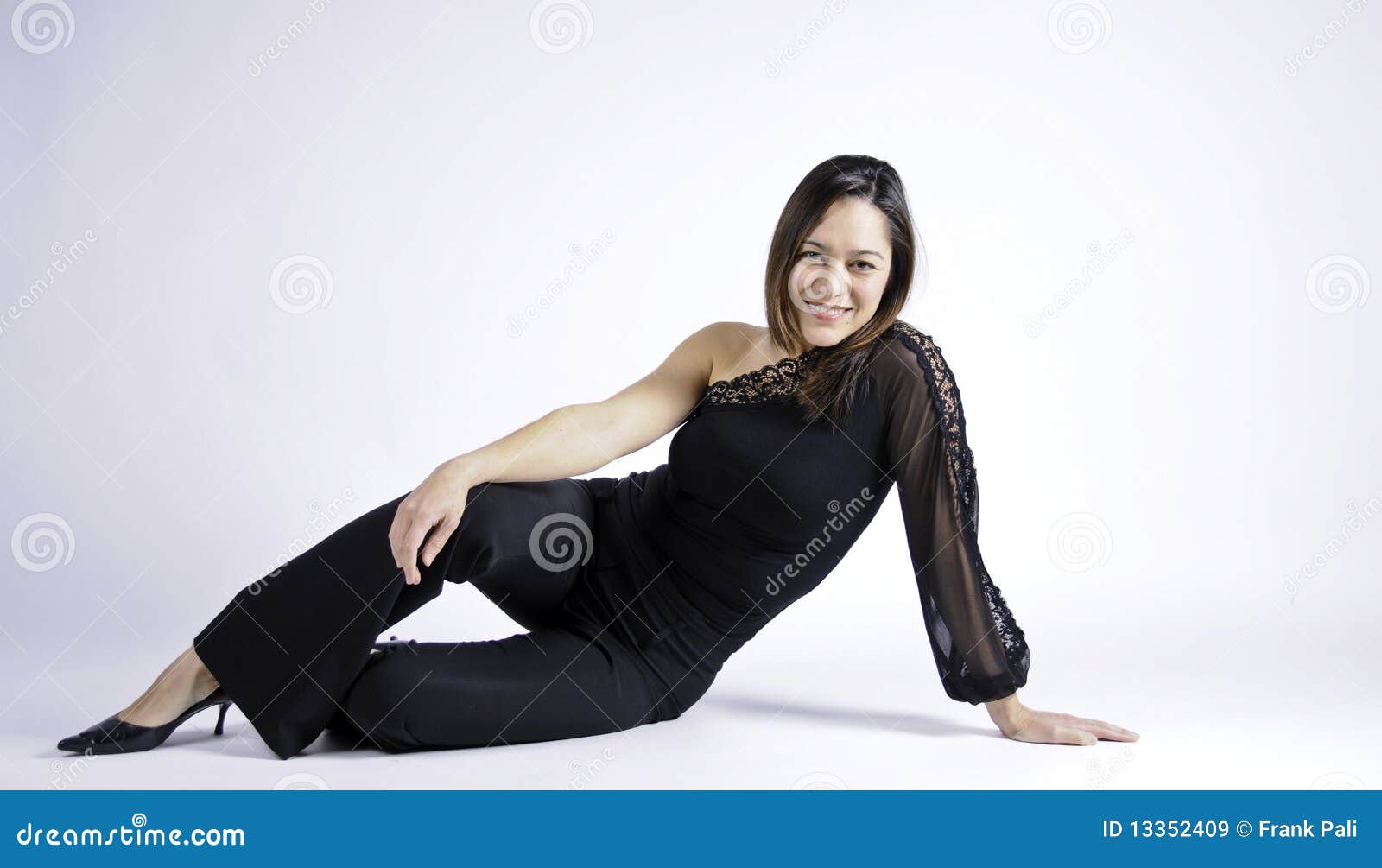 Woman sitting sideways stock image. Image of brunette - 13352409