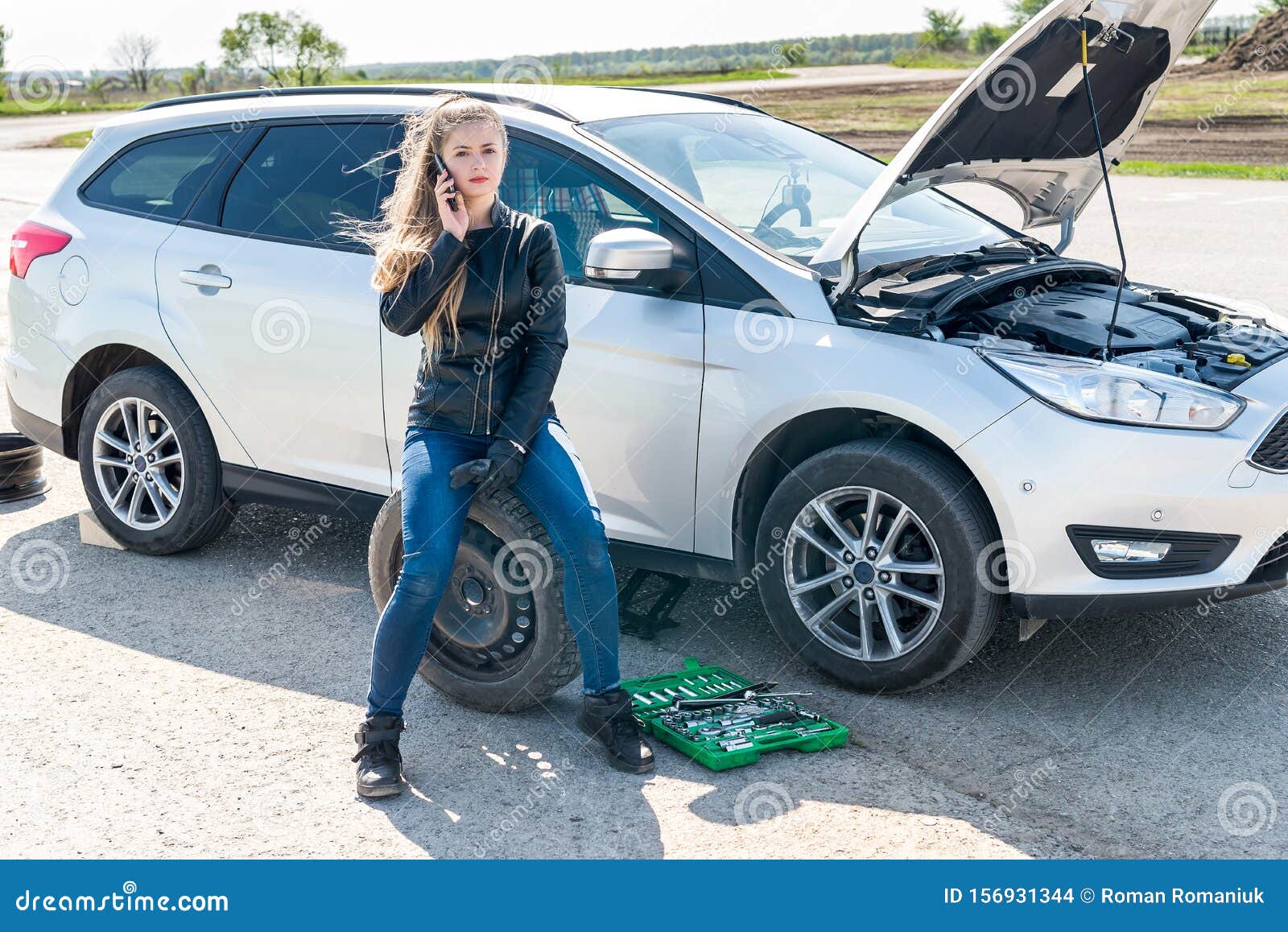 Woman Sitting on Spare Wheel Making a Call Stock Photo - Image of ...