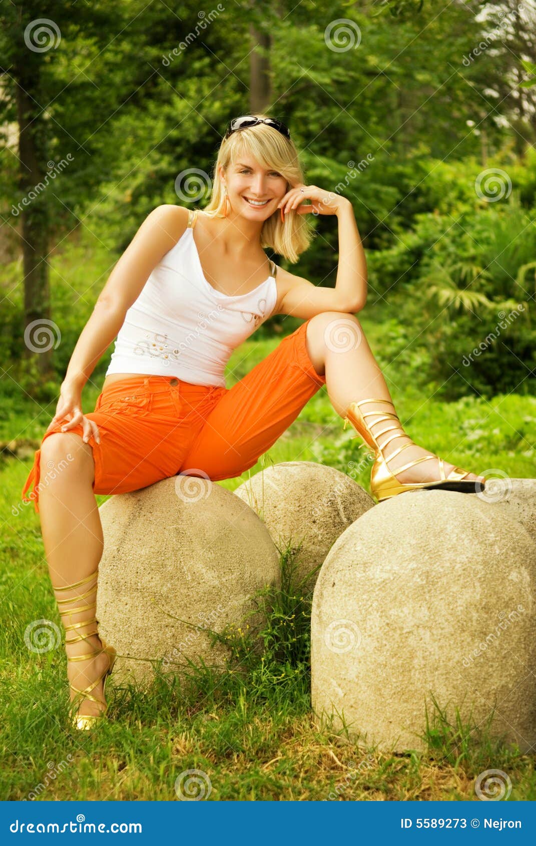 Woman sitting on a stone stock image. Image of outdoors - 5589273