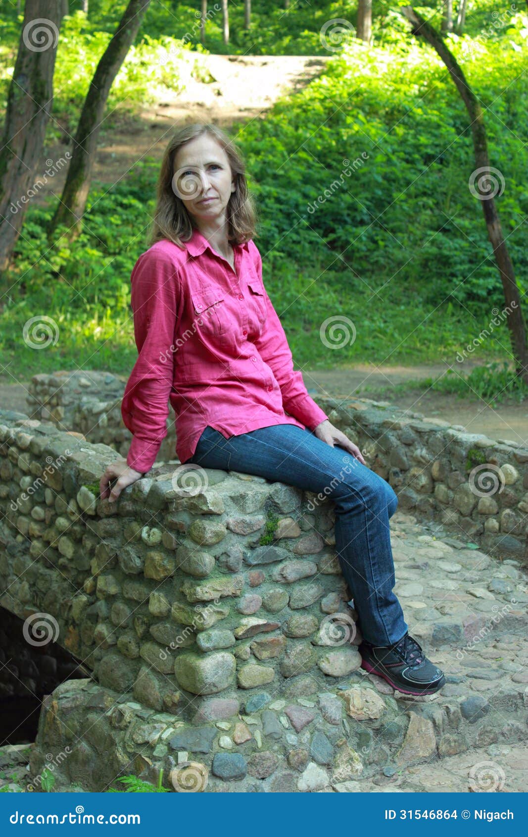A Woman Sitting on a Stone Bridge Parapet Stock Photo - Image of sunny ...