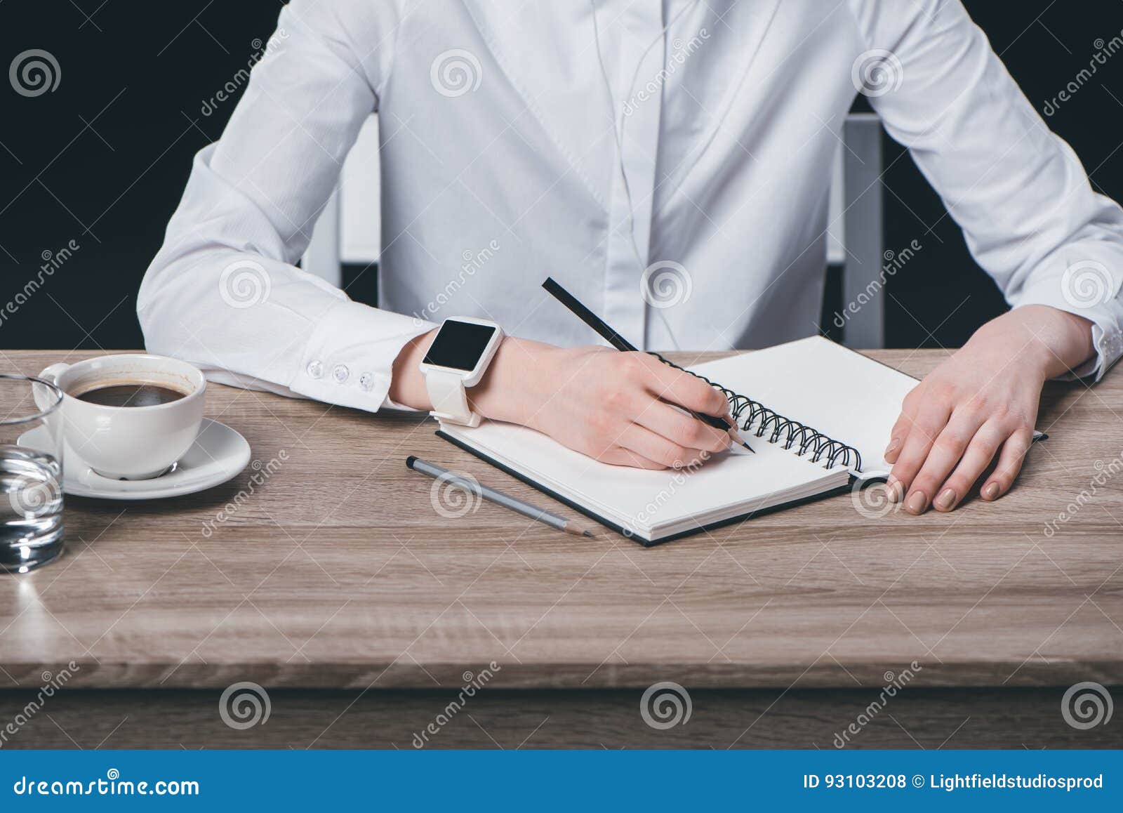 Woman Sitting at Table and Making Notes Stock Photo - Image of glass ...
