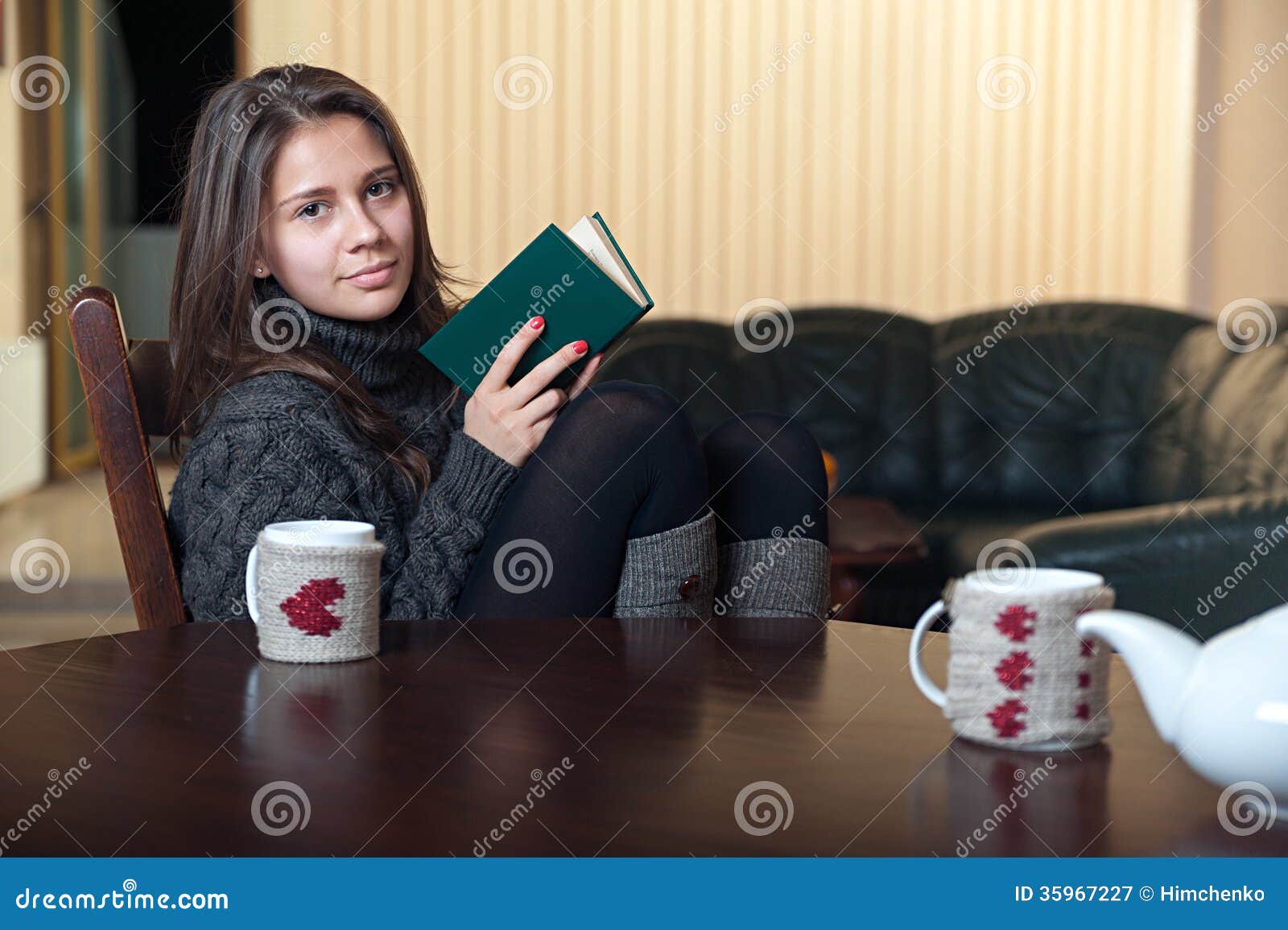 Woman Sitting at a Table and Reading a Book Stock Image - Image of ...