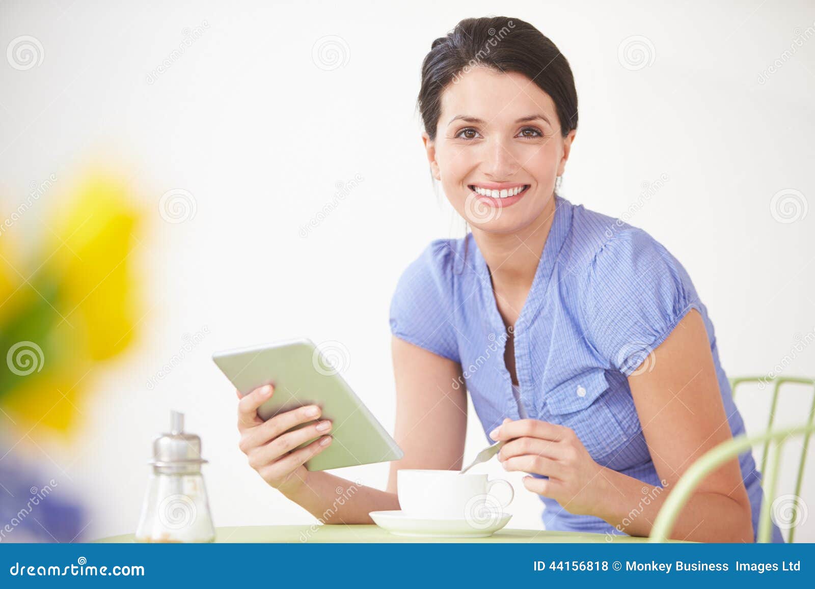 Woman Sitting at Table Using Digital Tablet Stock Photo - Image of ...