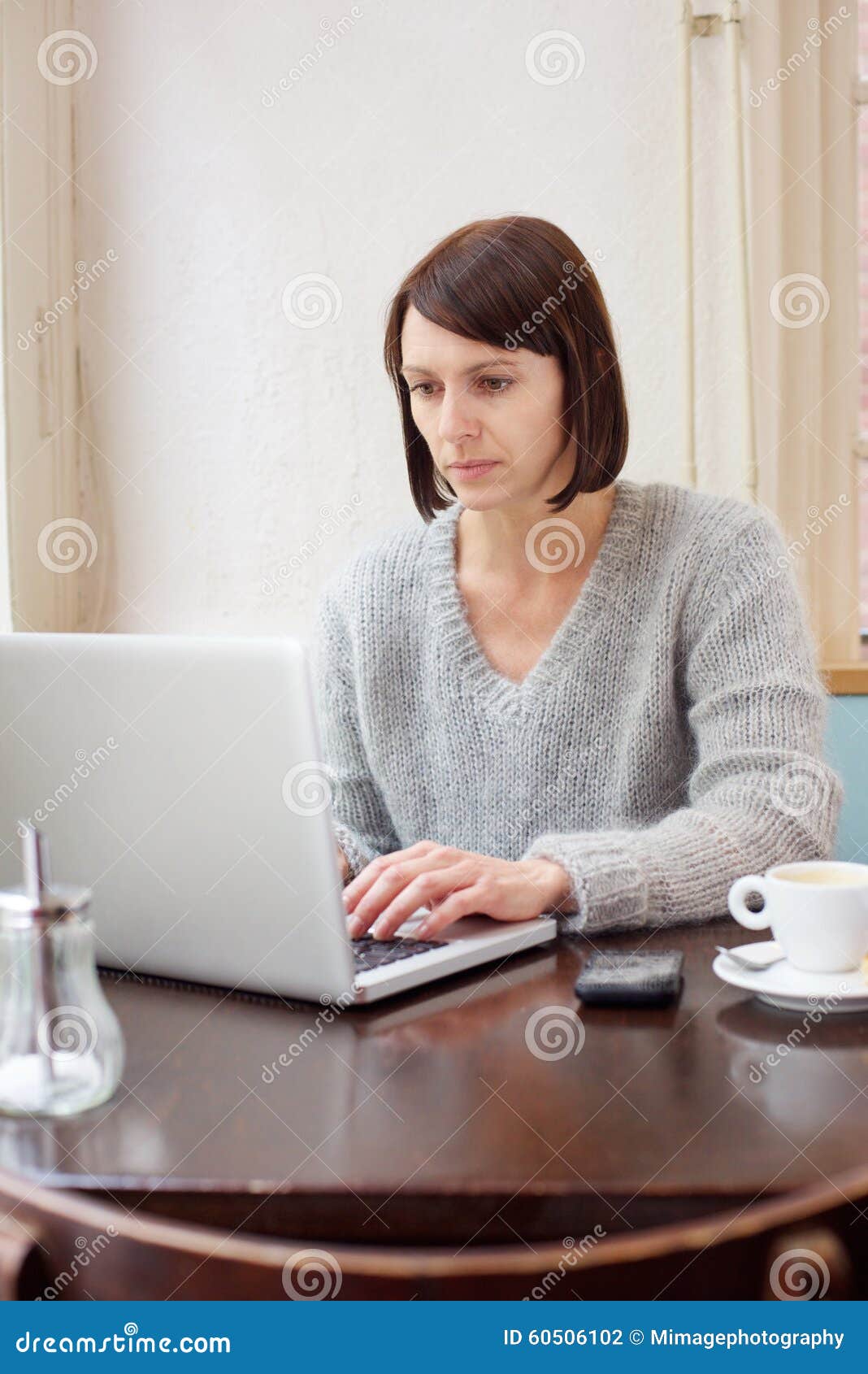 Woman Sitting at Table Using Laptop Stock Photo - Image of attractive ...