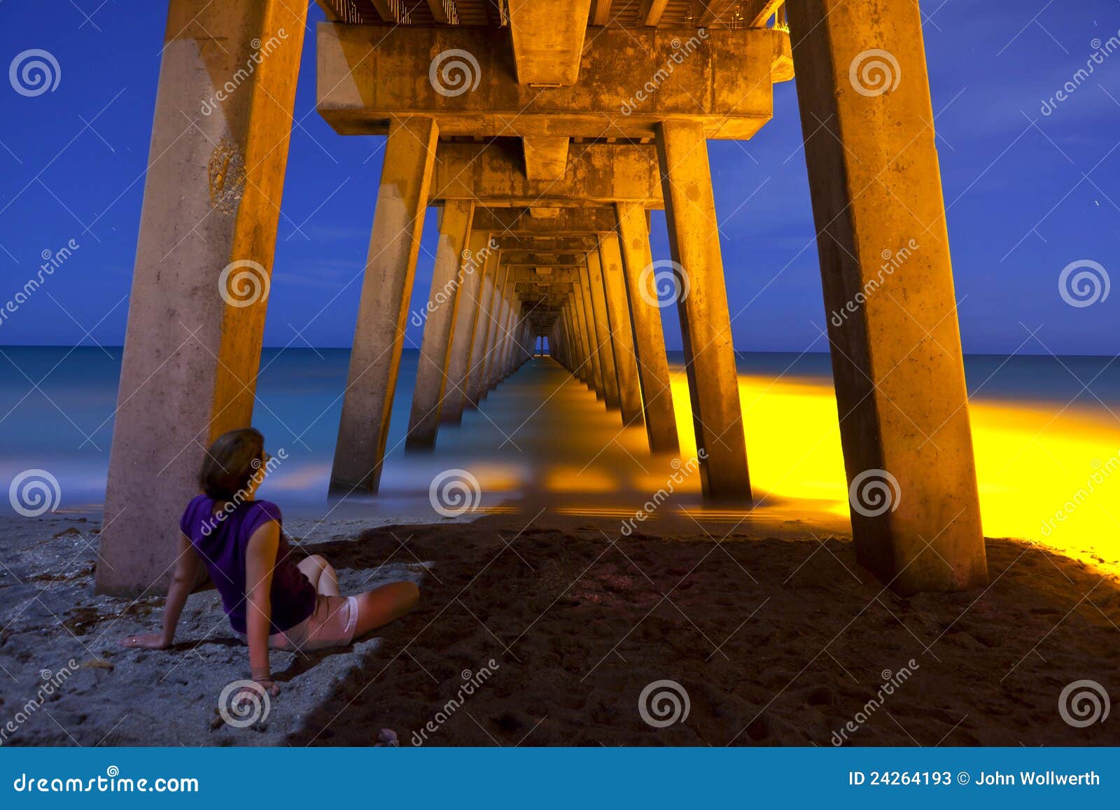 Woman Sitting Under Pier at Night Stock Image - Image of spectacular ...