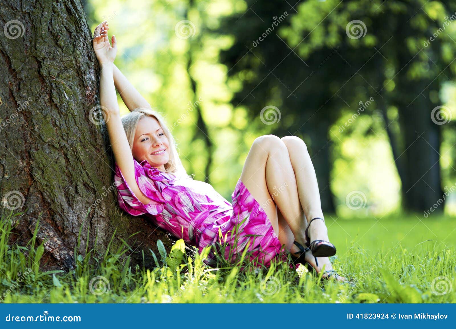 Woman sitting under tree stock photo. Image of blond - 41823924