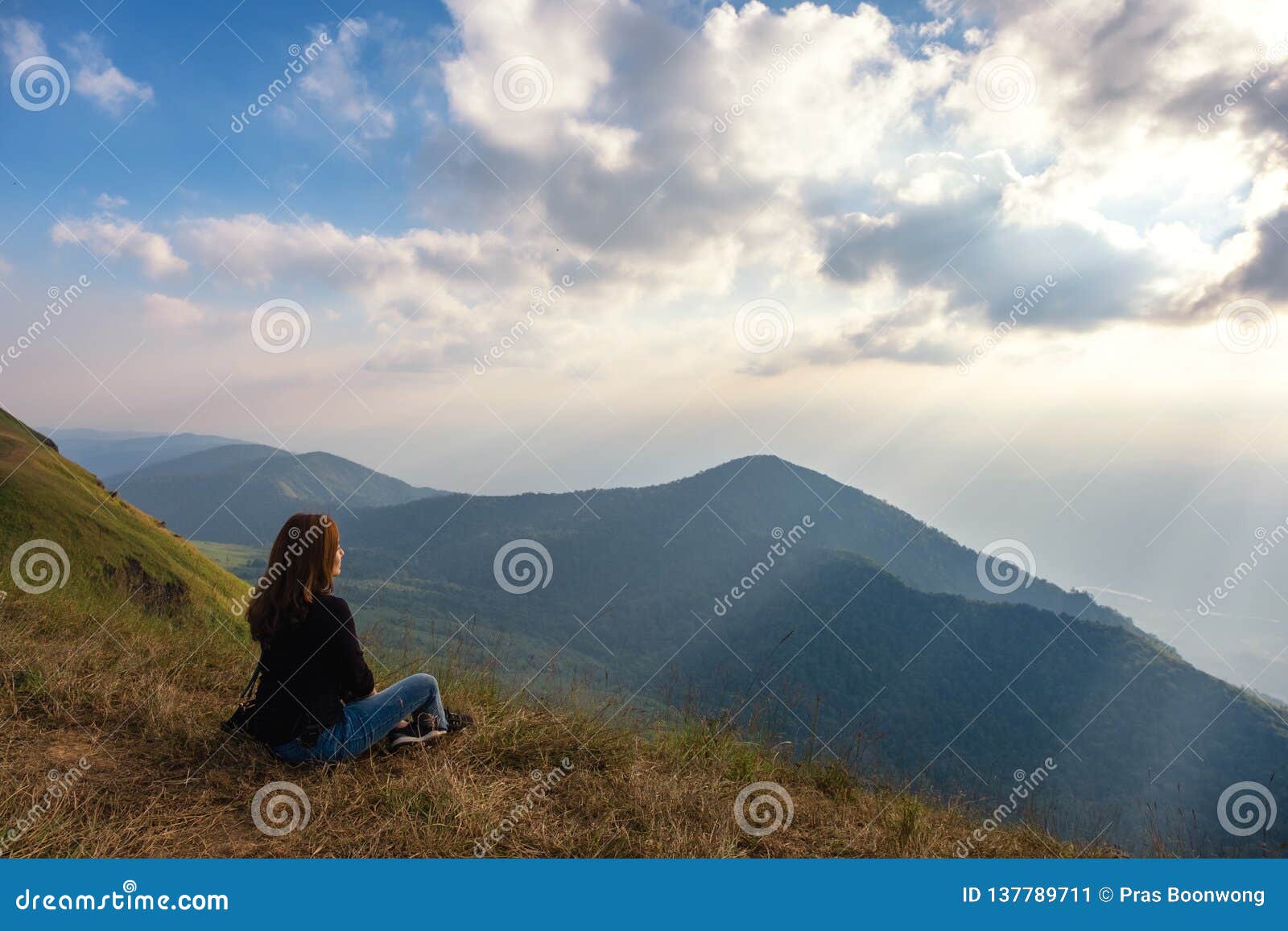 A Woman Sitting and Watching Sunset with Mountains View Stock Image ...