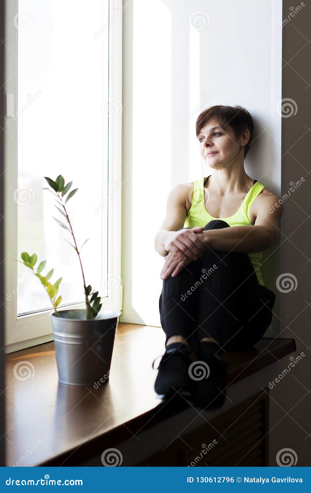 Woman Sitting on the Window and Looking into the Distance Stock Photo ...