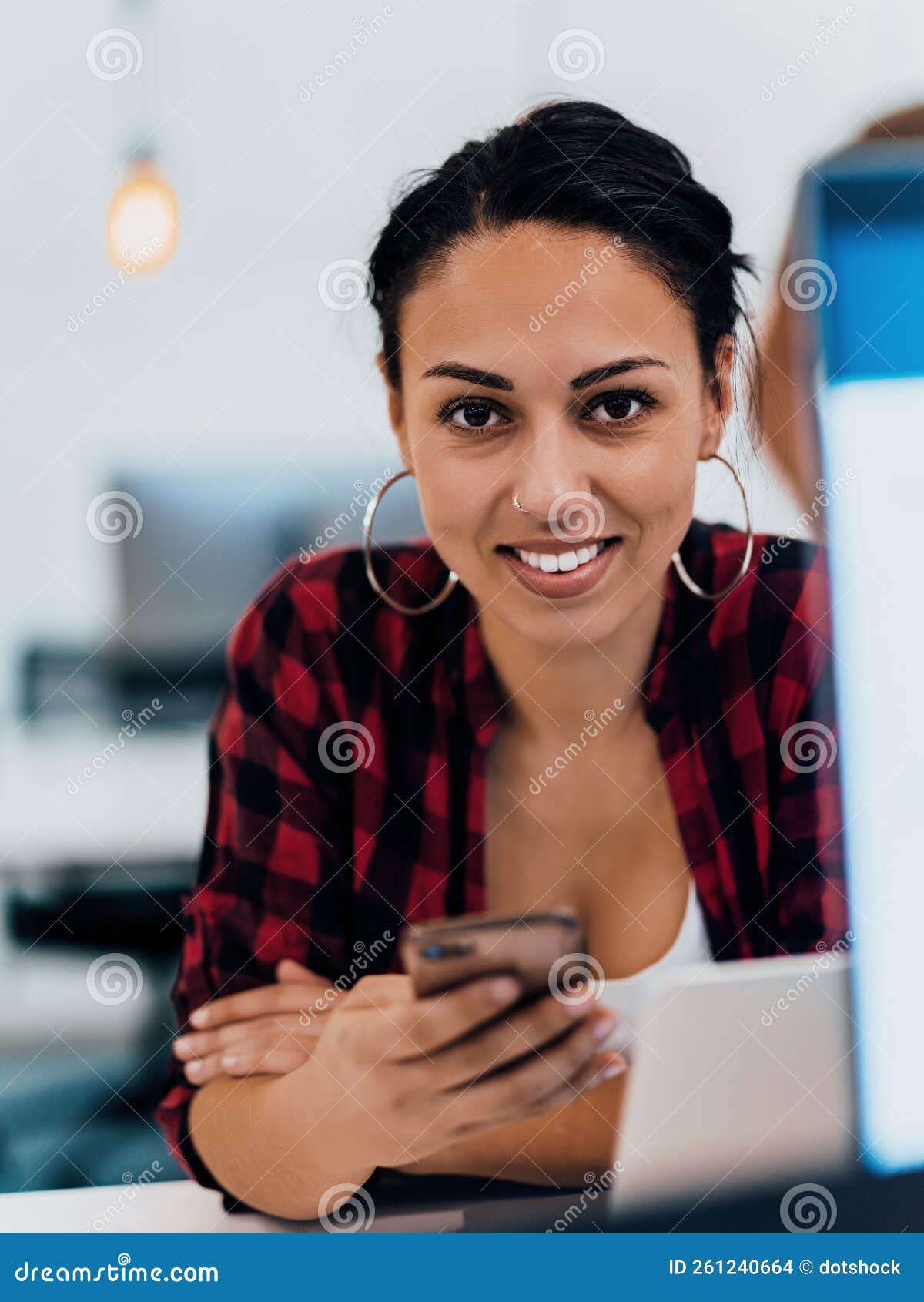 Woman Sitting at Workplace Desk Holds Smartphone Staring at Laptop ...