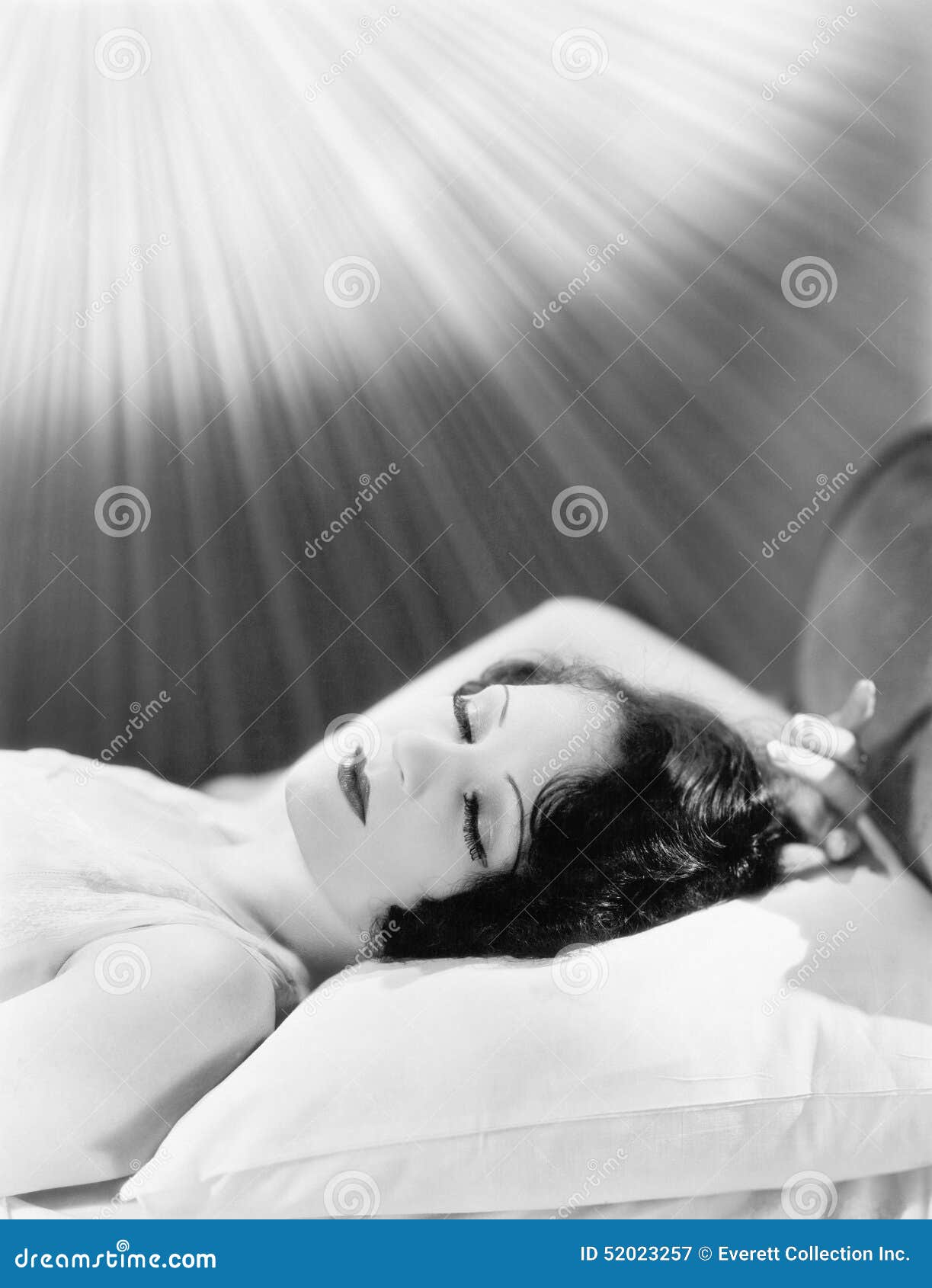 Woman Sleeping in a Bed with Rays of Light Shining on Her Stock Image ...