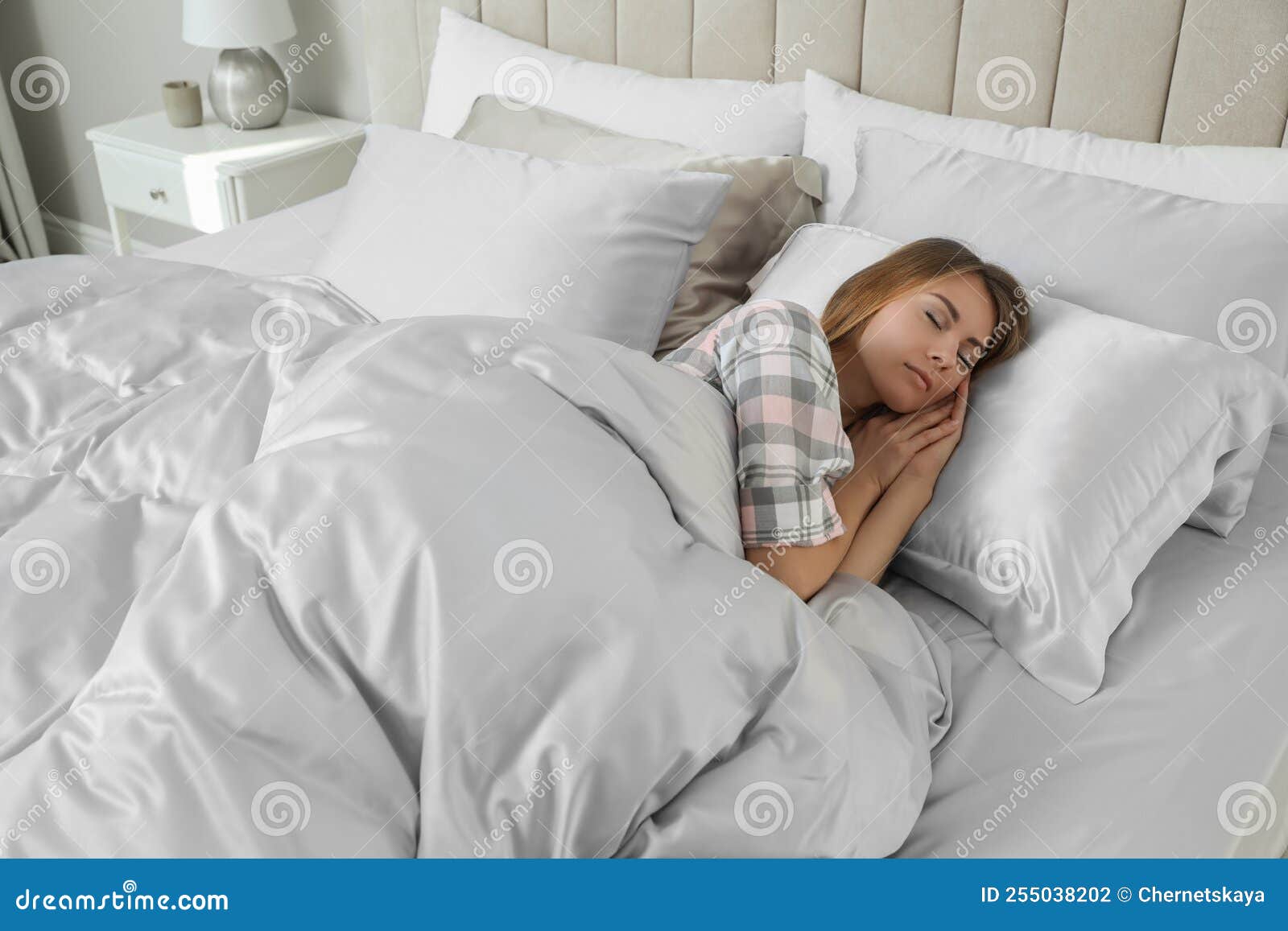 Woman Sleeping in Comfortable Bed with Silky Linens Stock Photo - Image ...