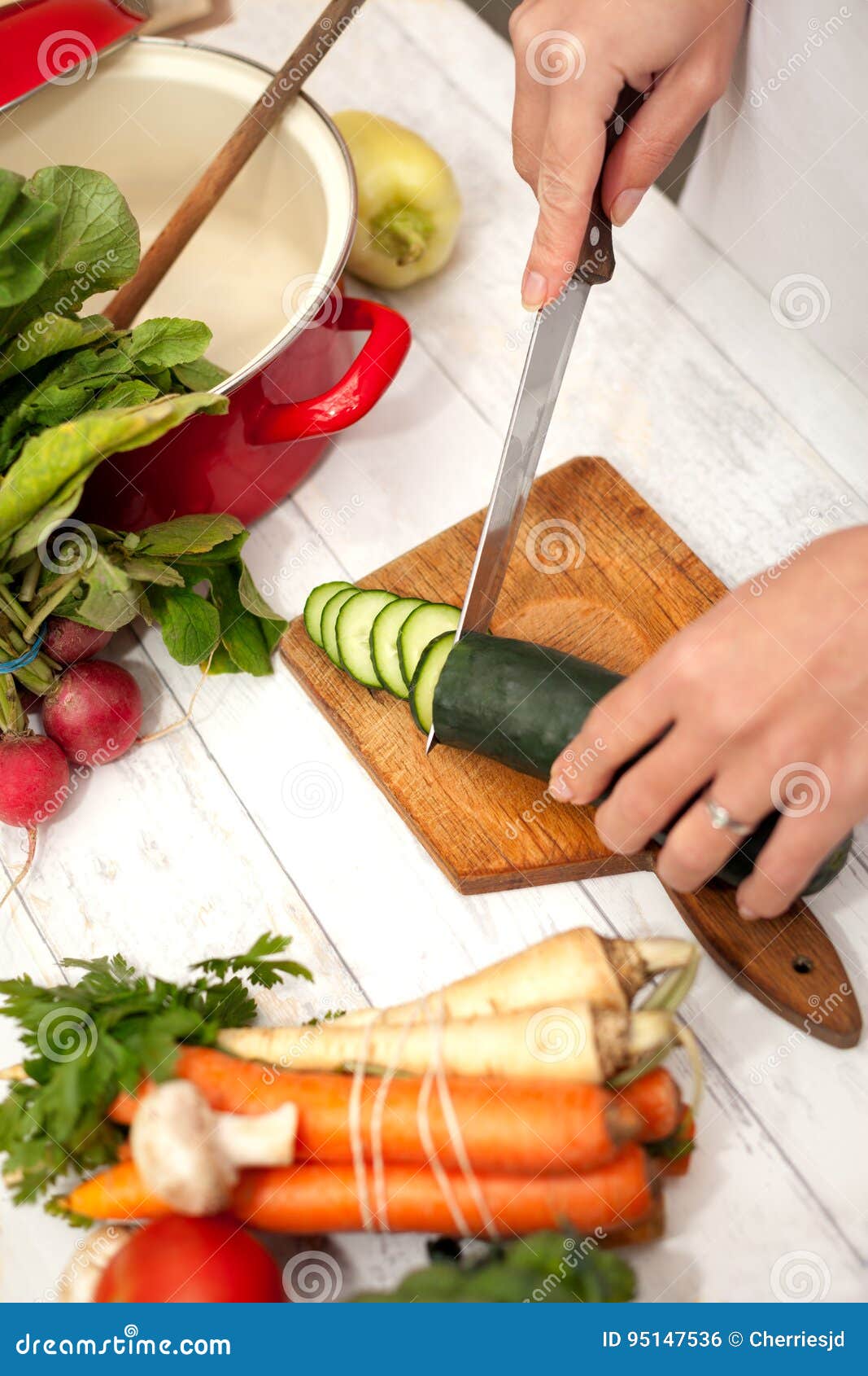 Woman slicing cucumber stock photo. Image of eating, gastronomy - 95147536