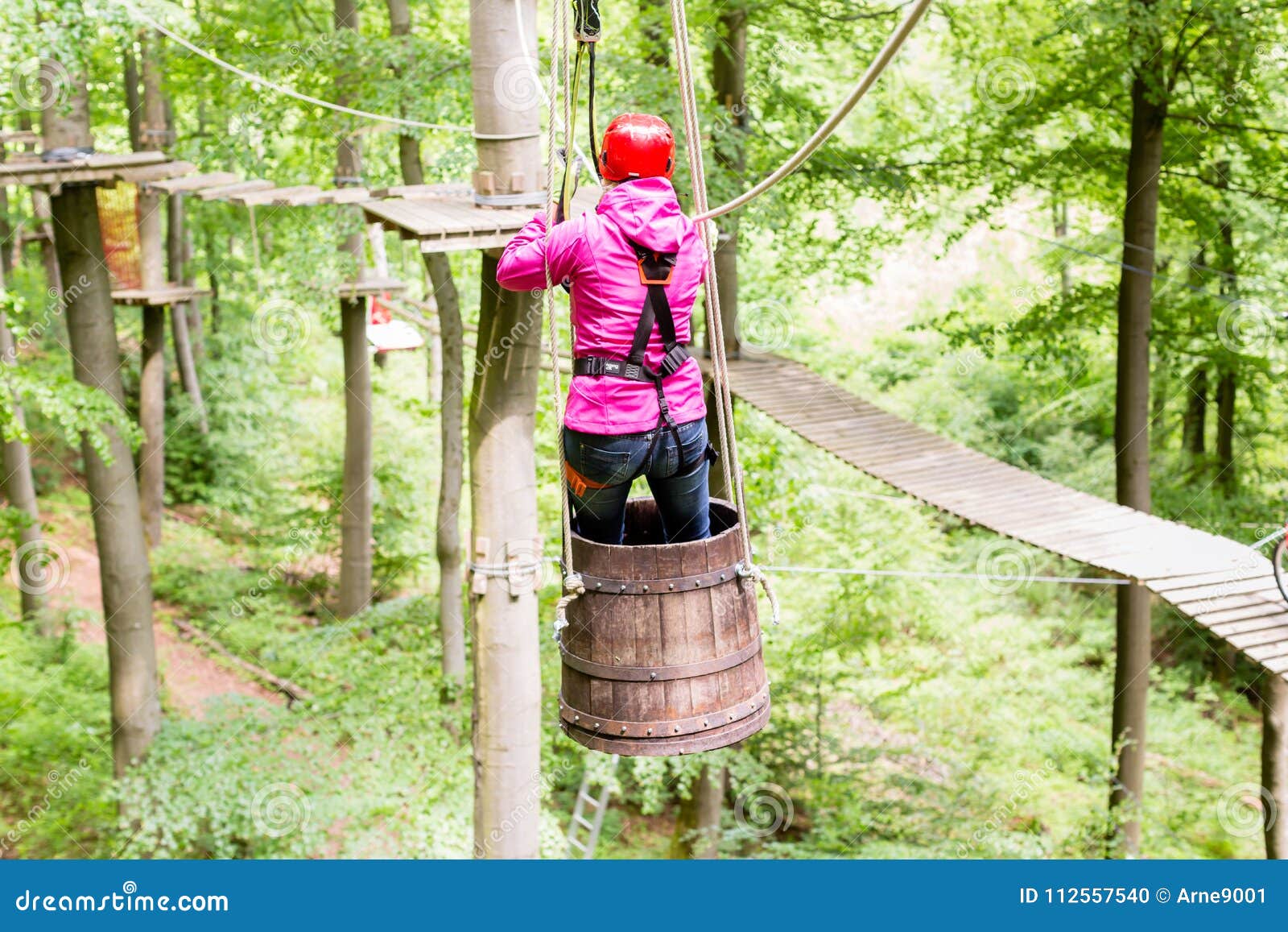 Woman Sliding in Barrel at High Rope Climbing Course Stock Photo ...