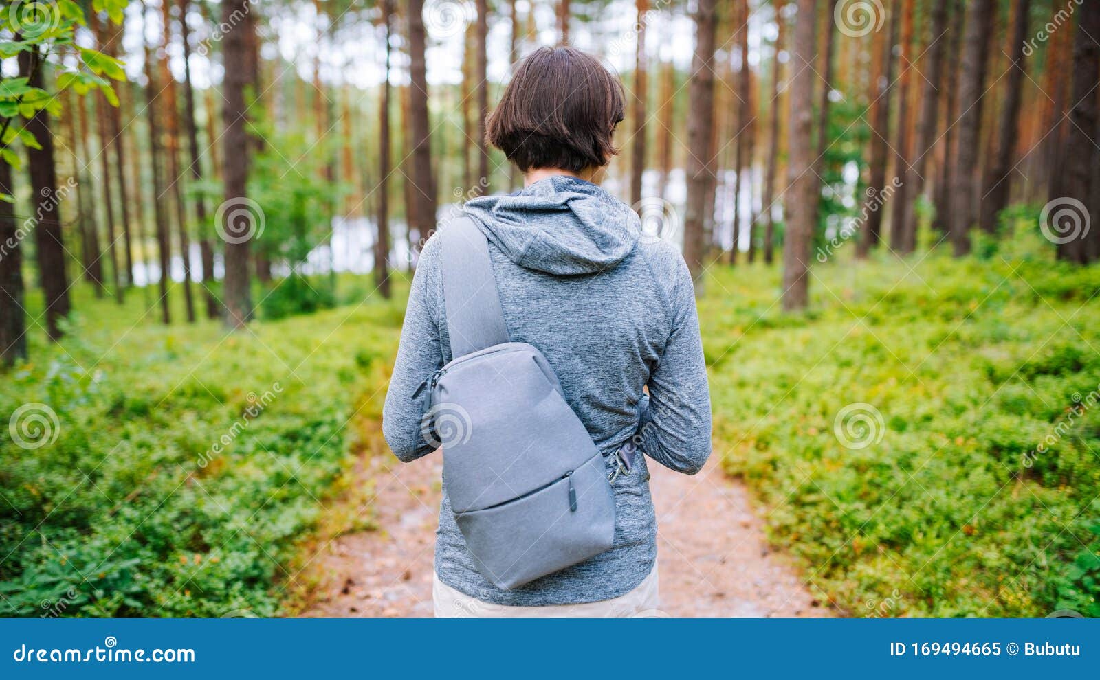 Woman with a Small Backpack on a Walk in the Forest Stock Image - Image ...