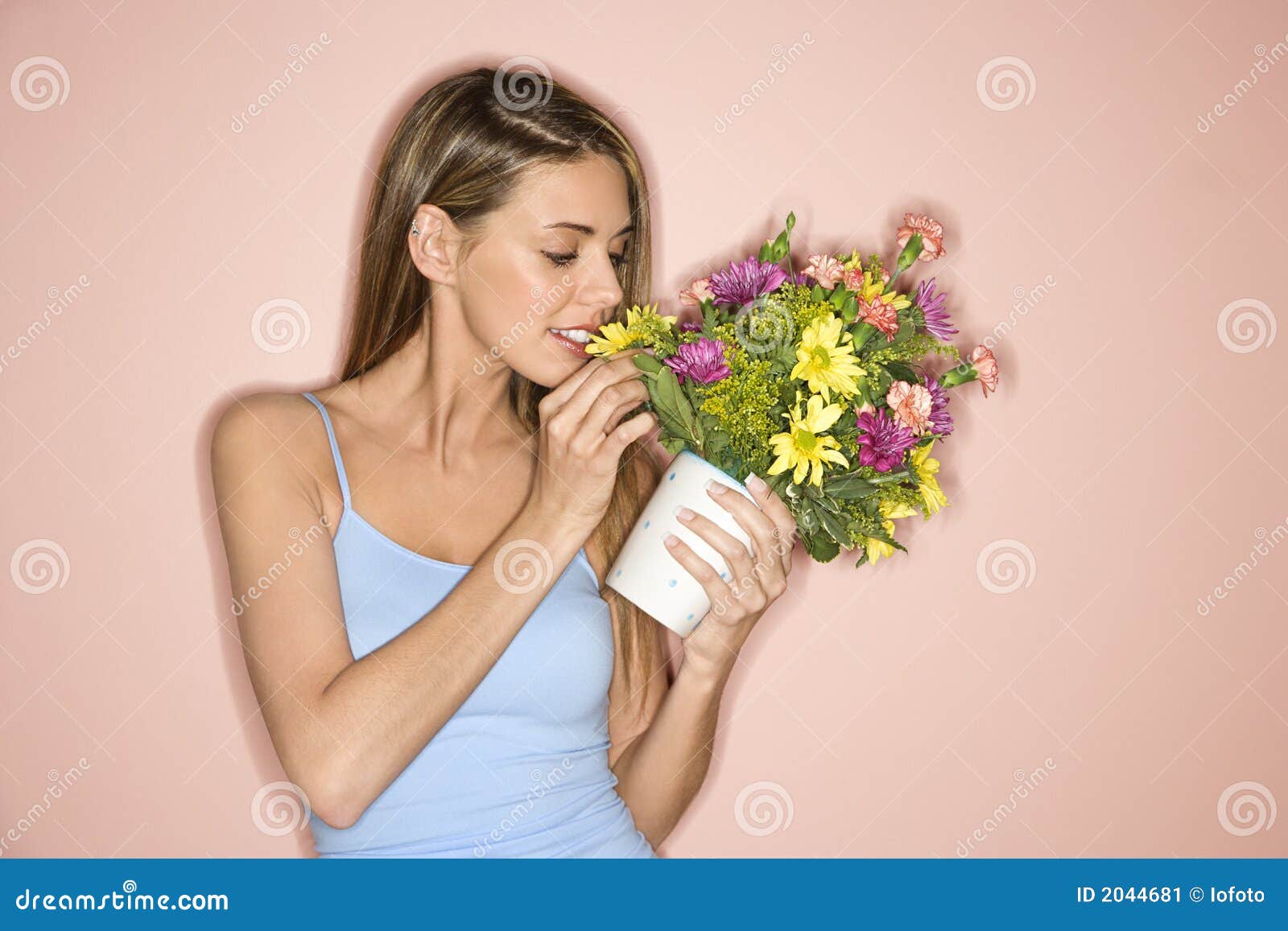 A woman smelling flowers. stock image. Image of smelling - 2044681