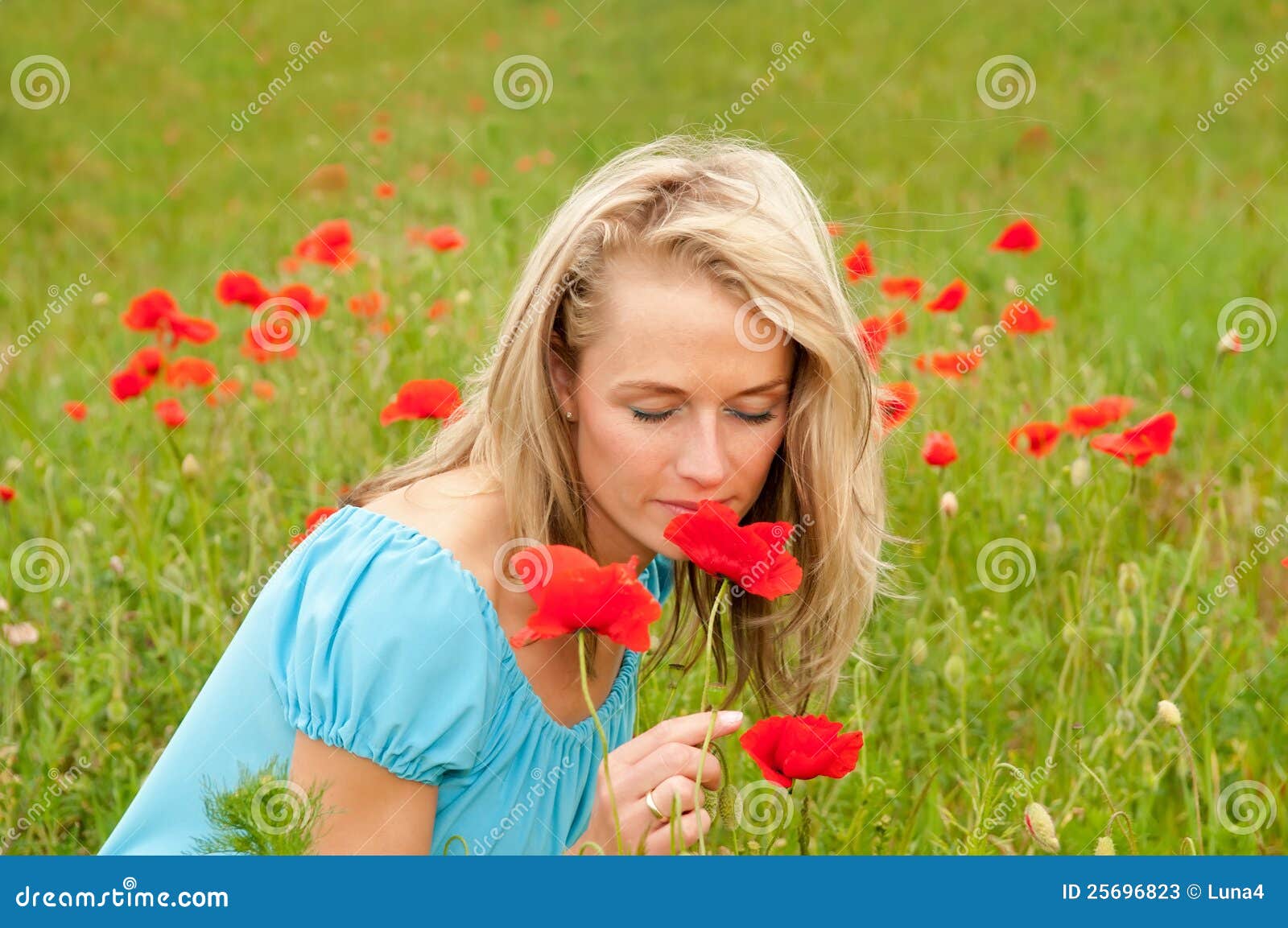 Woman smelling a poppy stock image. Image of outdoors - 25696823