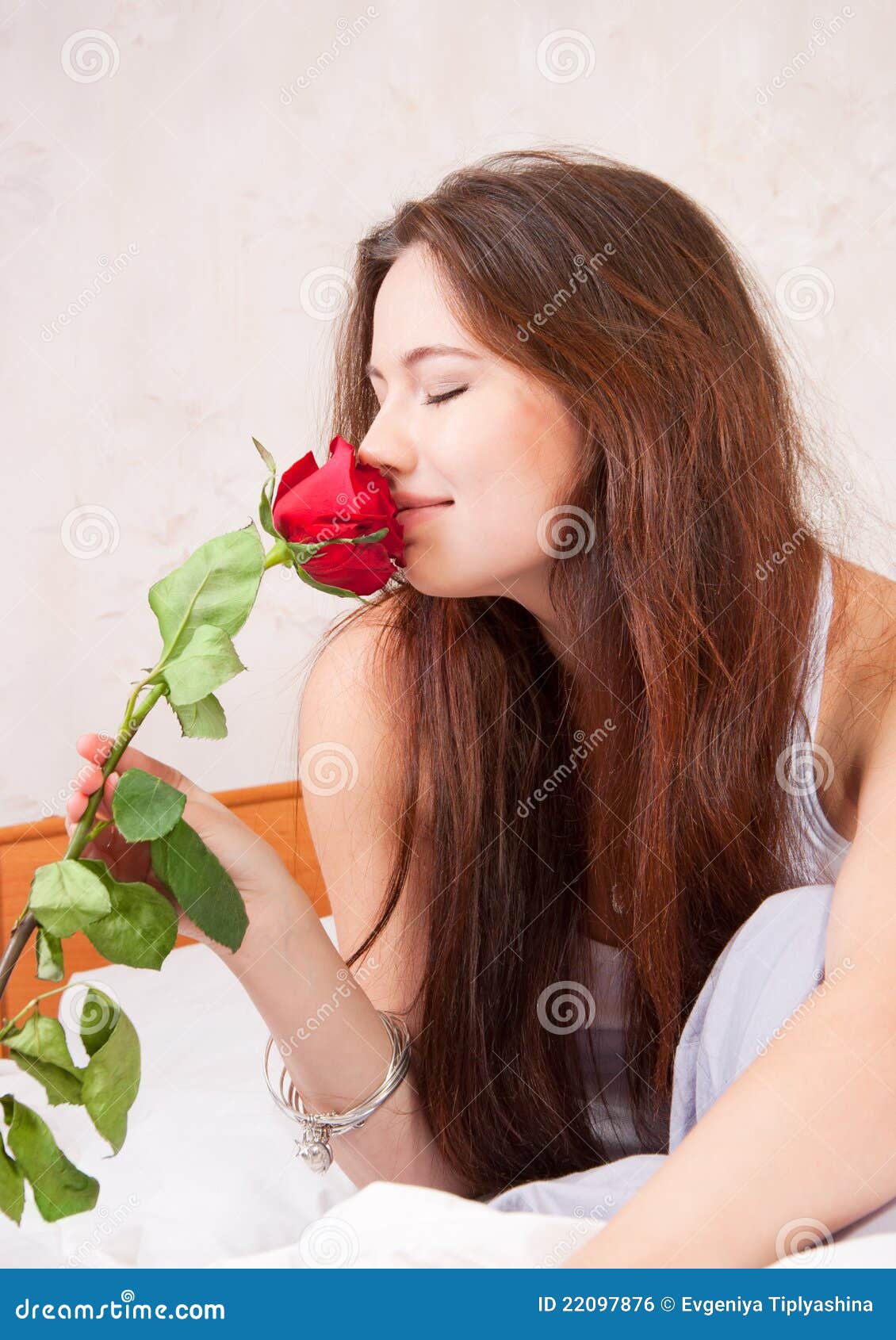 Woman smelling a rose stock photo. Image of hair, home - 22097876