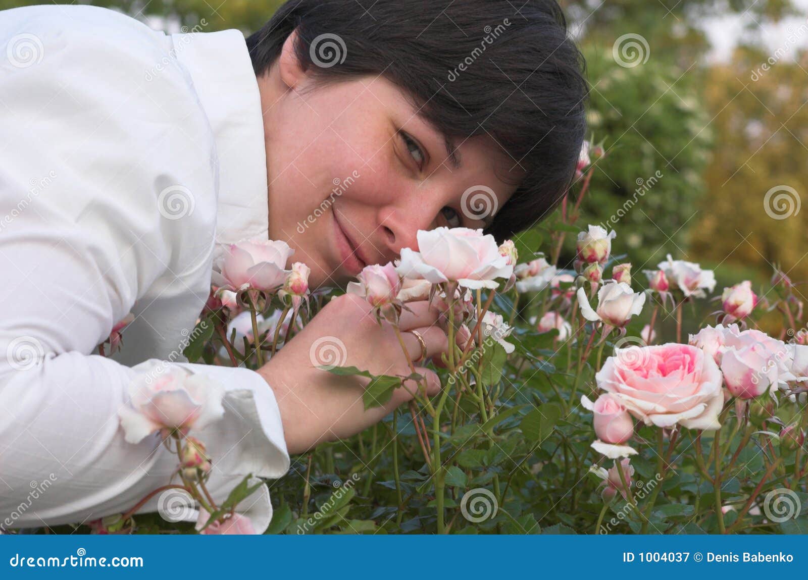 Woman smells roses stock image. Image of eyes, happy, lifestyle - 1004037