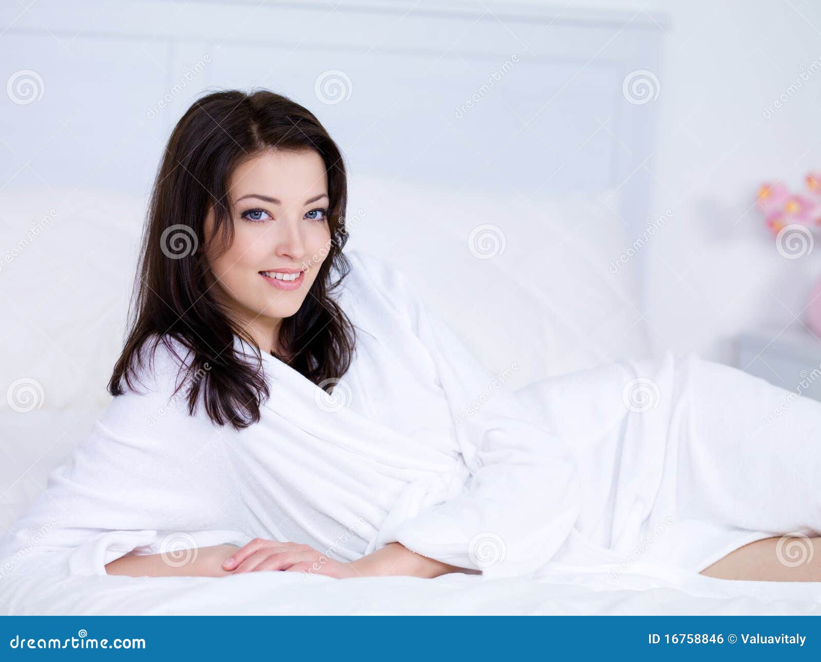 Woman with smile on a bed stock photo. Image of caucasian - 16758846