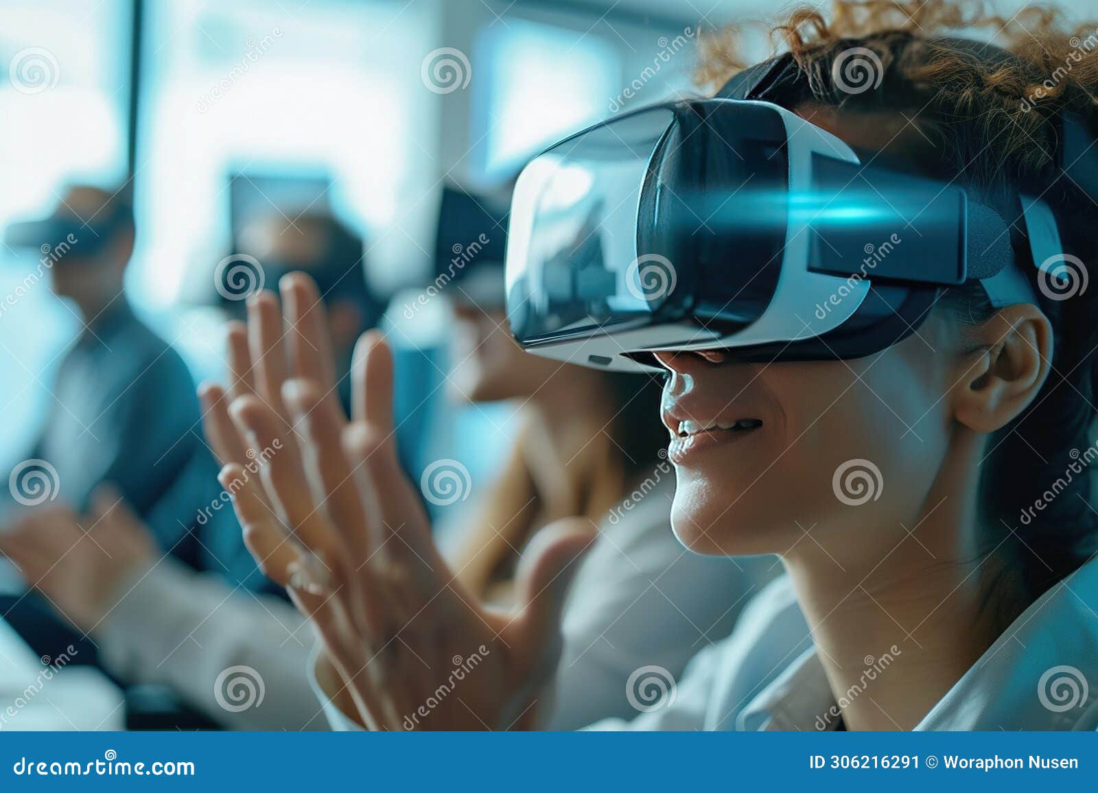 A Woman Smiles As she Uses a Virtual Reality Headset in a Group, Possibly during a Collaborative ...