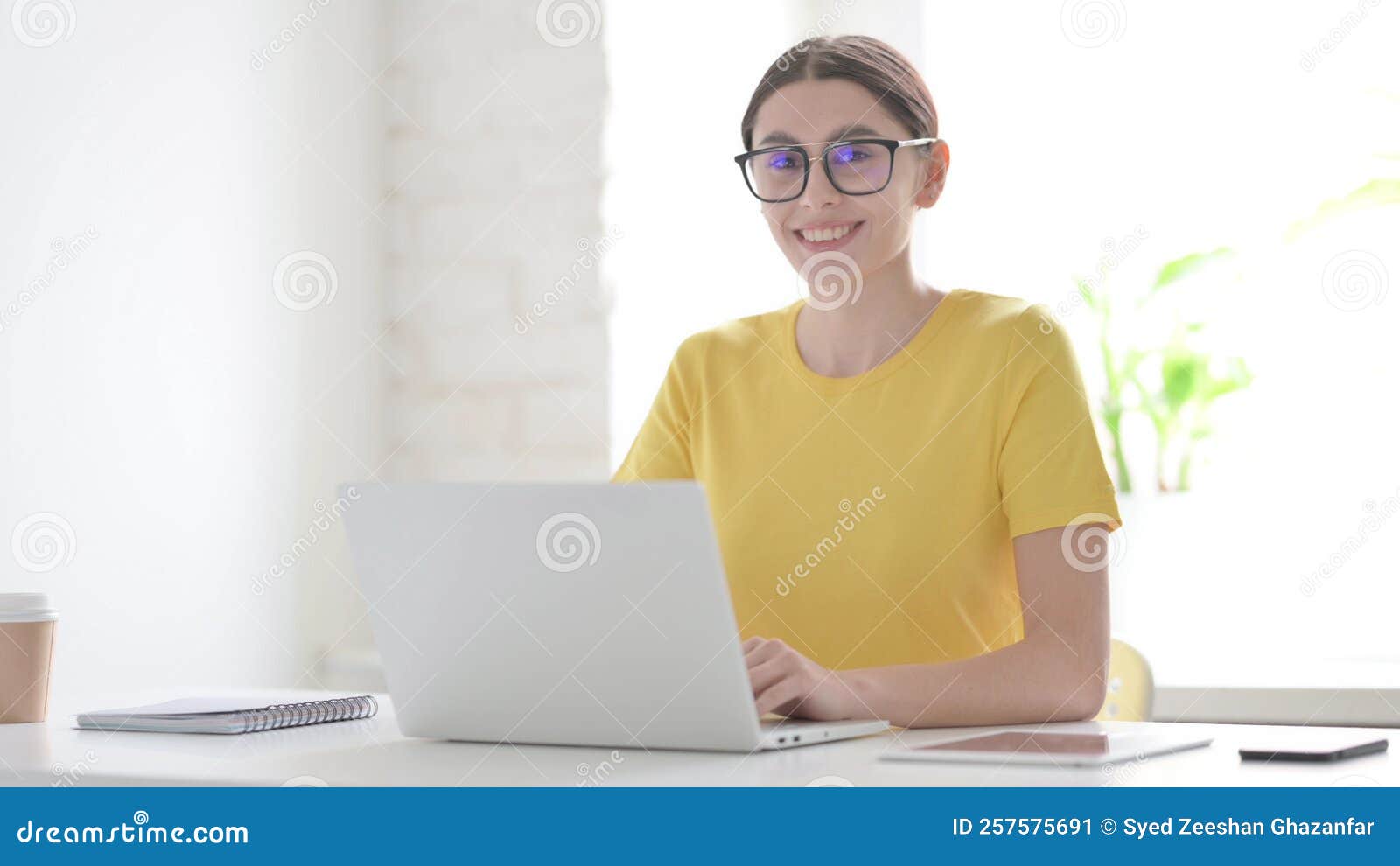 Woman Smiling at Camera while Using Laptop in Office Stock Image ...