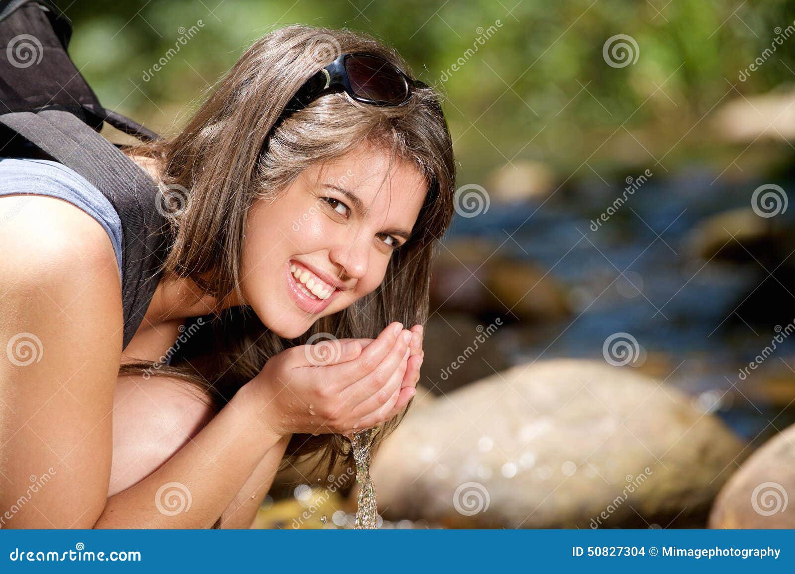 Woman Smiling and Drinking Water with Hands from Stream Stock Photo ...