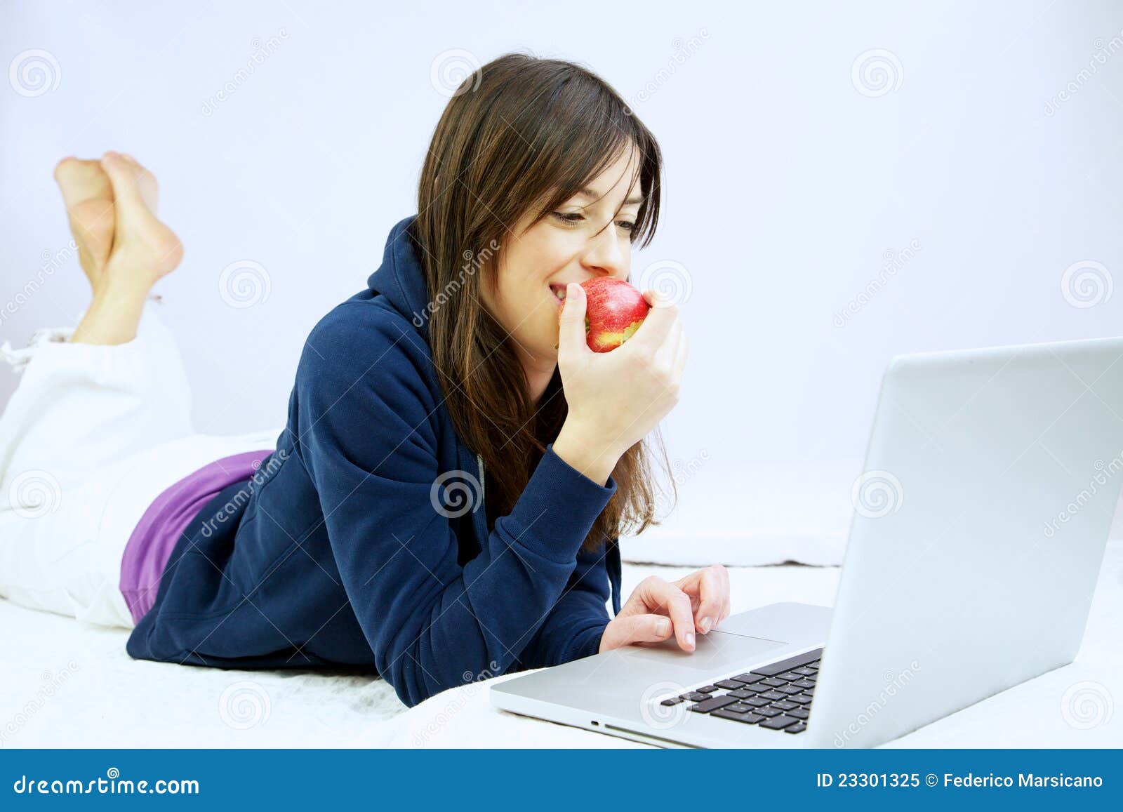 Woman Smiling Eats Apple in Front of Computer Stock Image - Image of ...