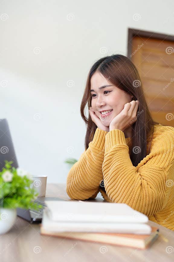 Woman Smiling Happily while Using Computer at Home Stock Photo - Image ...