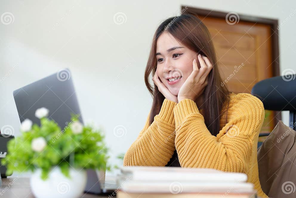 Woman Smiling Happily while Using Computer at Home Stock Photo - Image ...