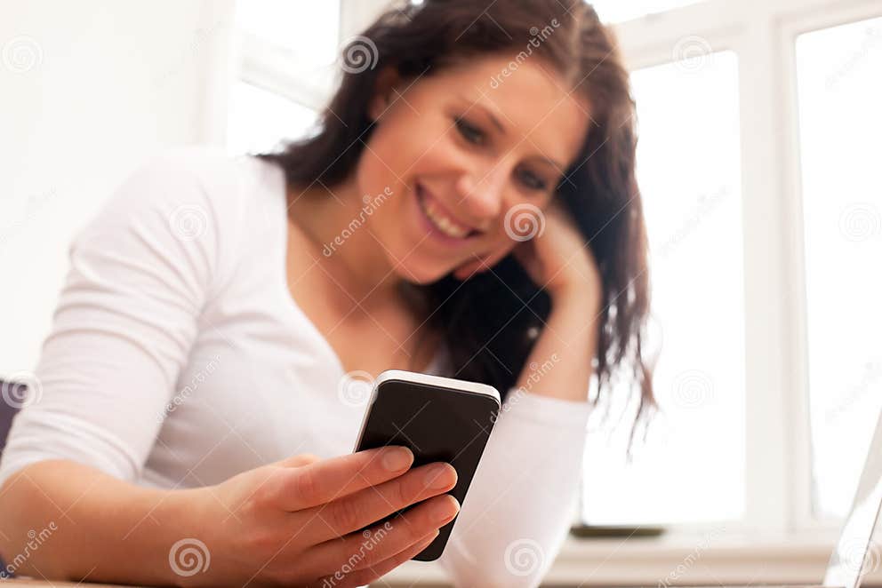 Woman Smiling while Reading Text Message Stock Photo - Image of network ...