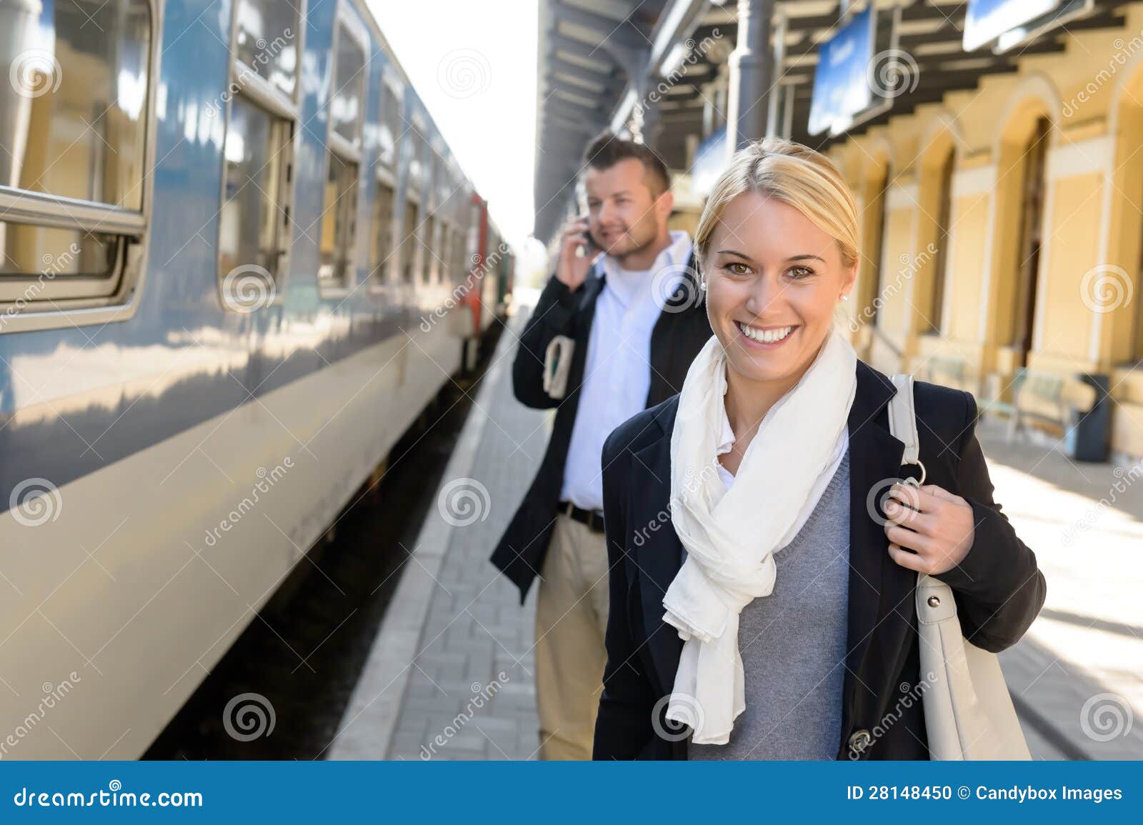 Woman Smiling in Train Station Man Phone Stock Photo - Image of ...