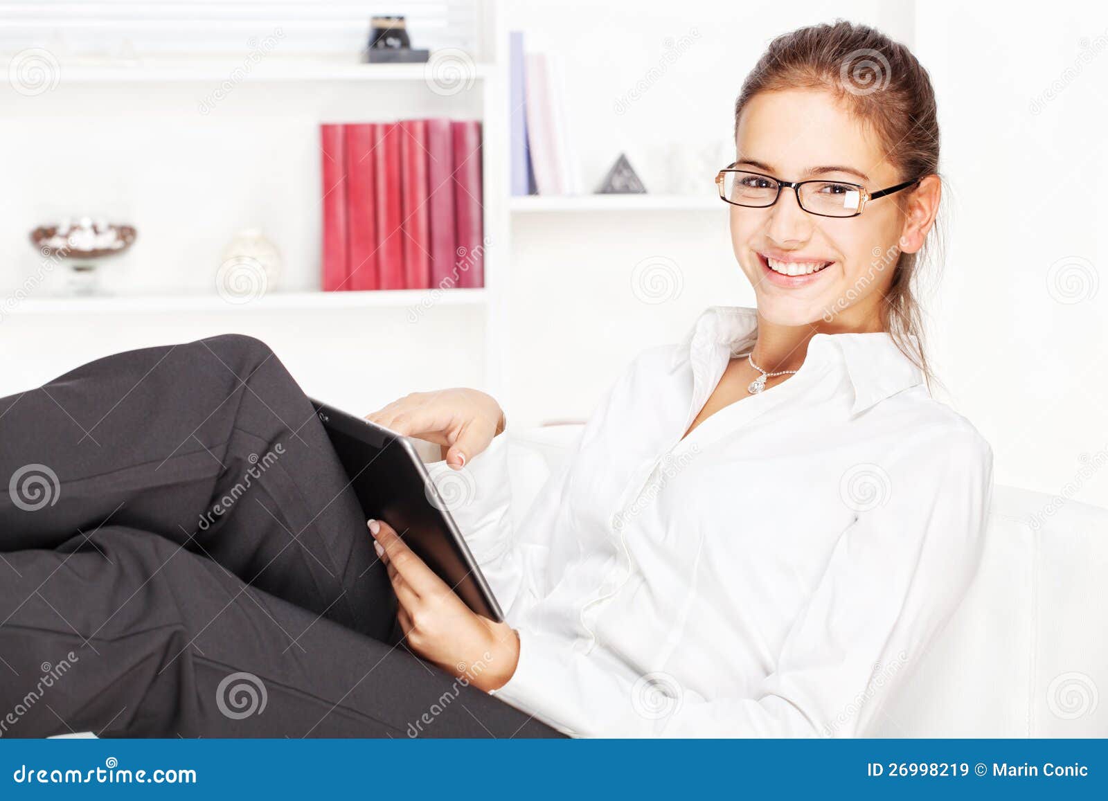 Woman Smiling while Working on Tablet Computer Stock Image - Image of ...